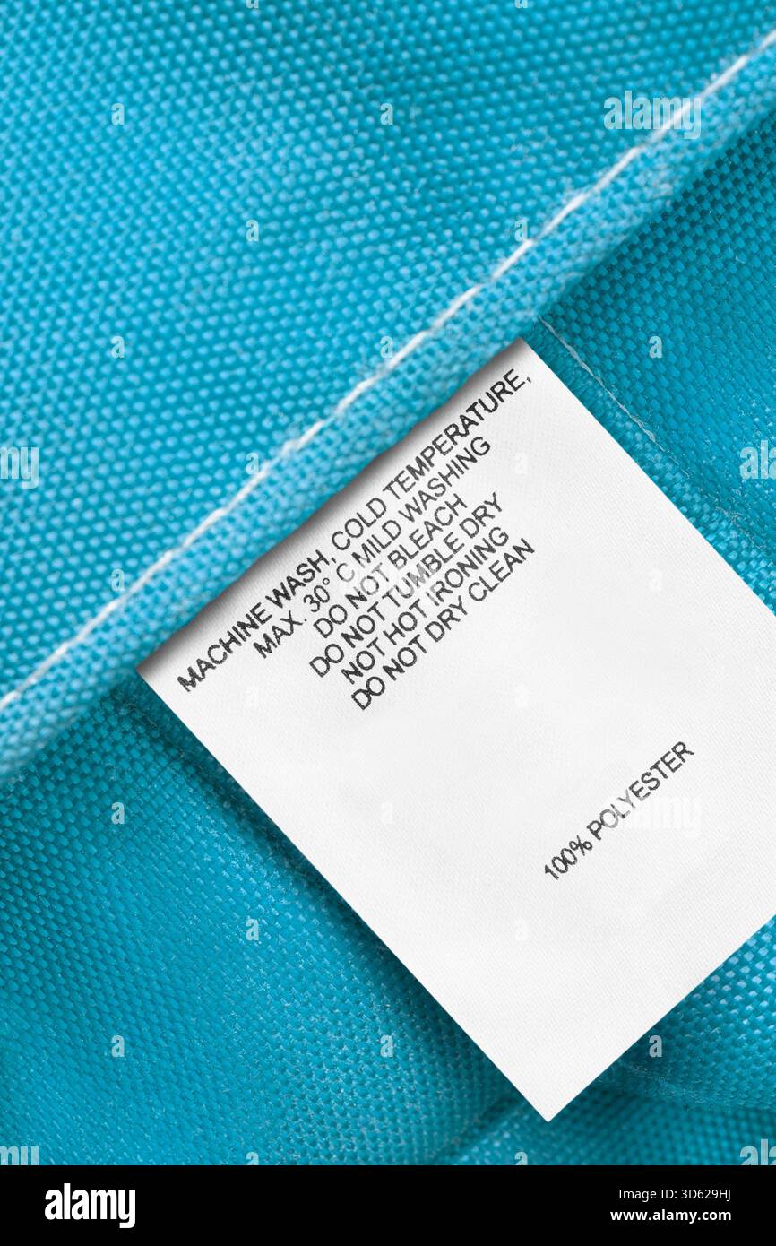 Washing instructions and fabric composition label on light blue fabric ...