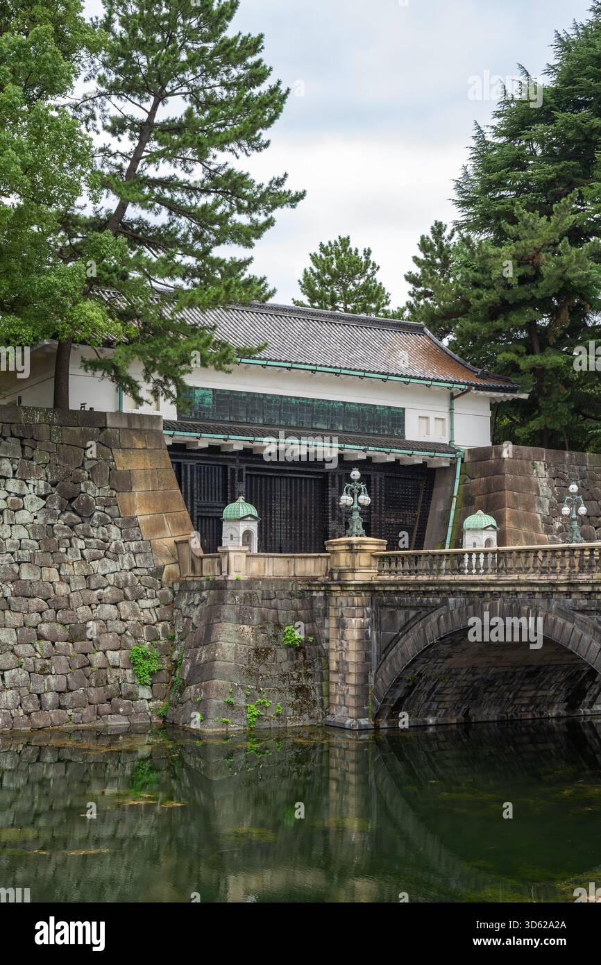 The historical stone Sakuradamon and bridge crossing the tranquil moat ...