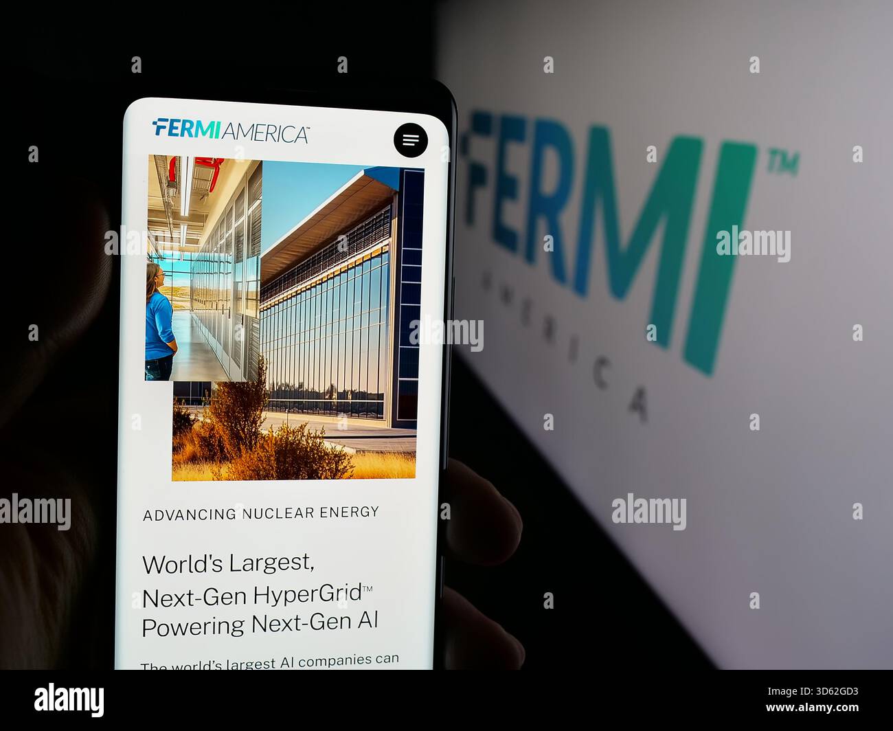 In this photo illustration, a person is holding a cellphone with the webpage of US energy ...