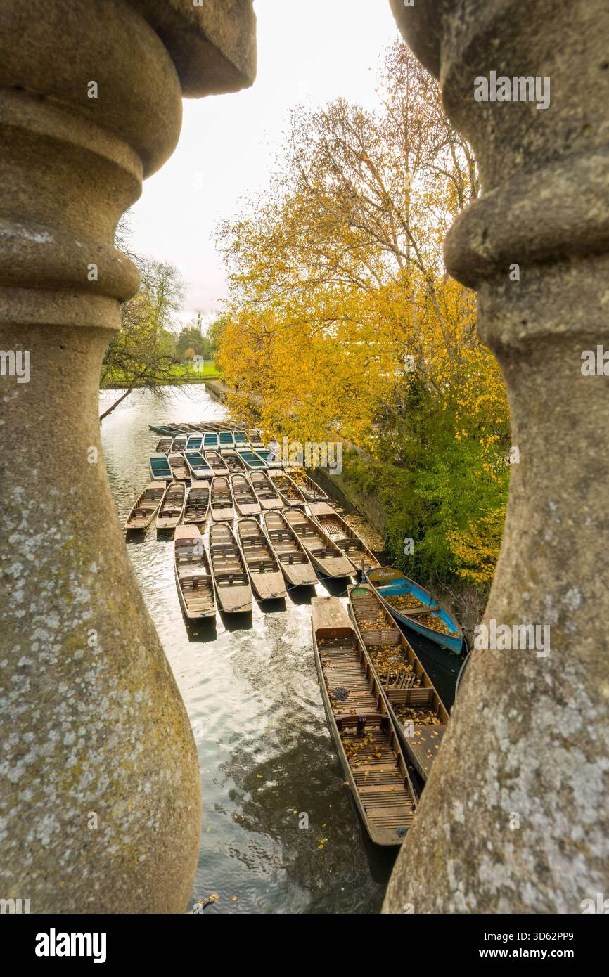 Punts moored up on the river Cherwell through the balustrades of ...