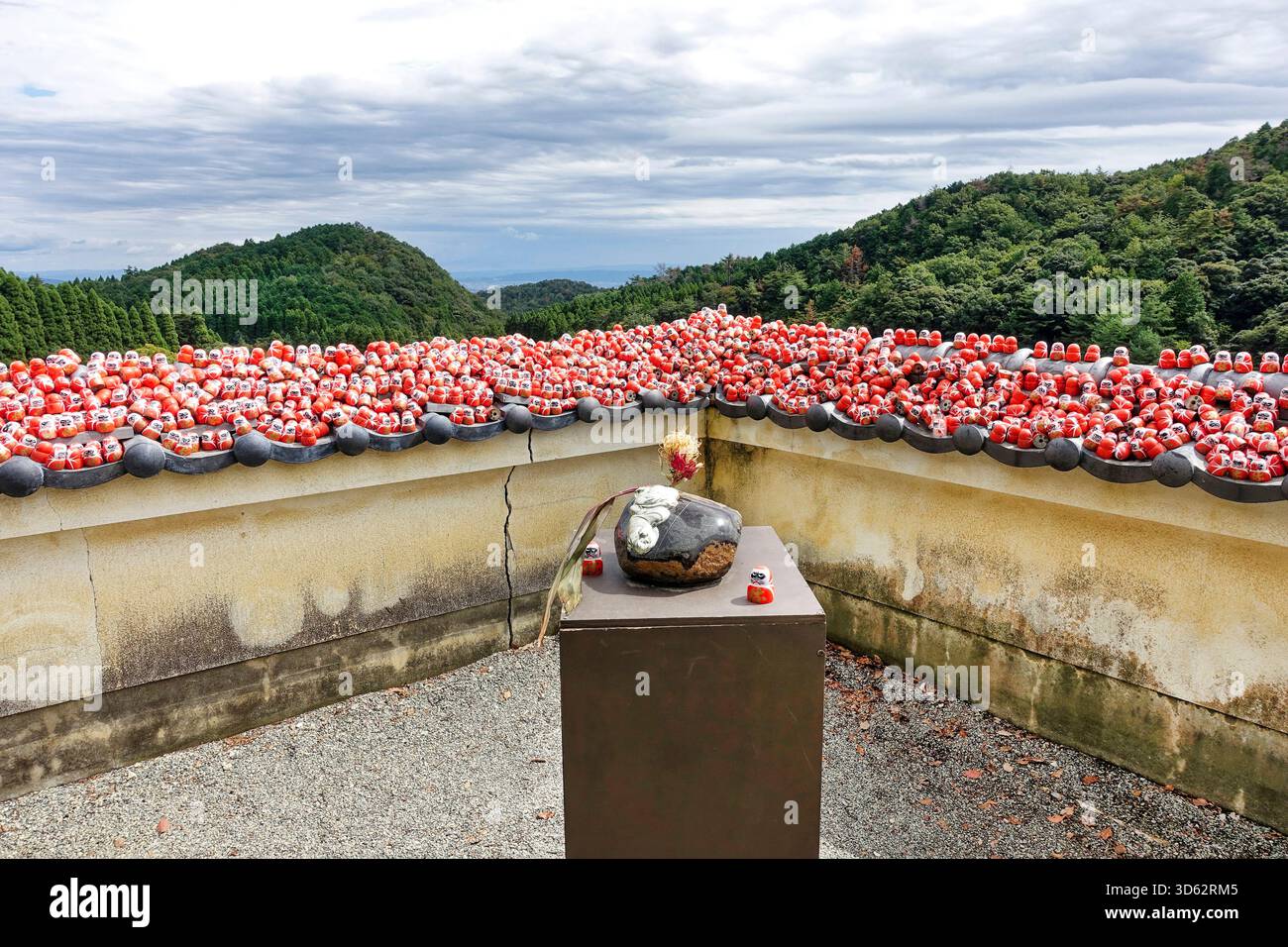 many small Daruma lucky charms placed on a typical Japanese wall in ...
