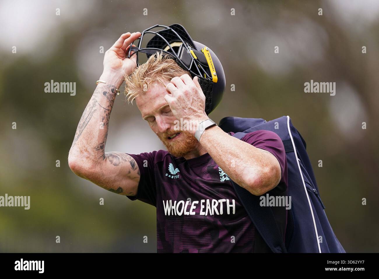 England’s Ben Stokes takes off his helmet and wipes his forehead during ...