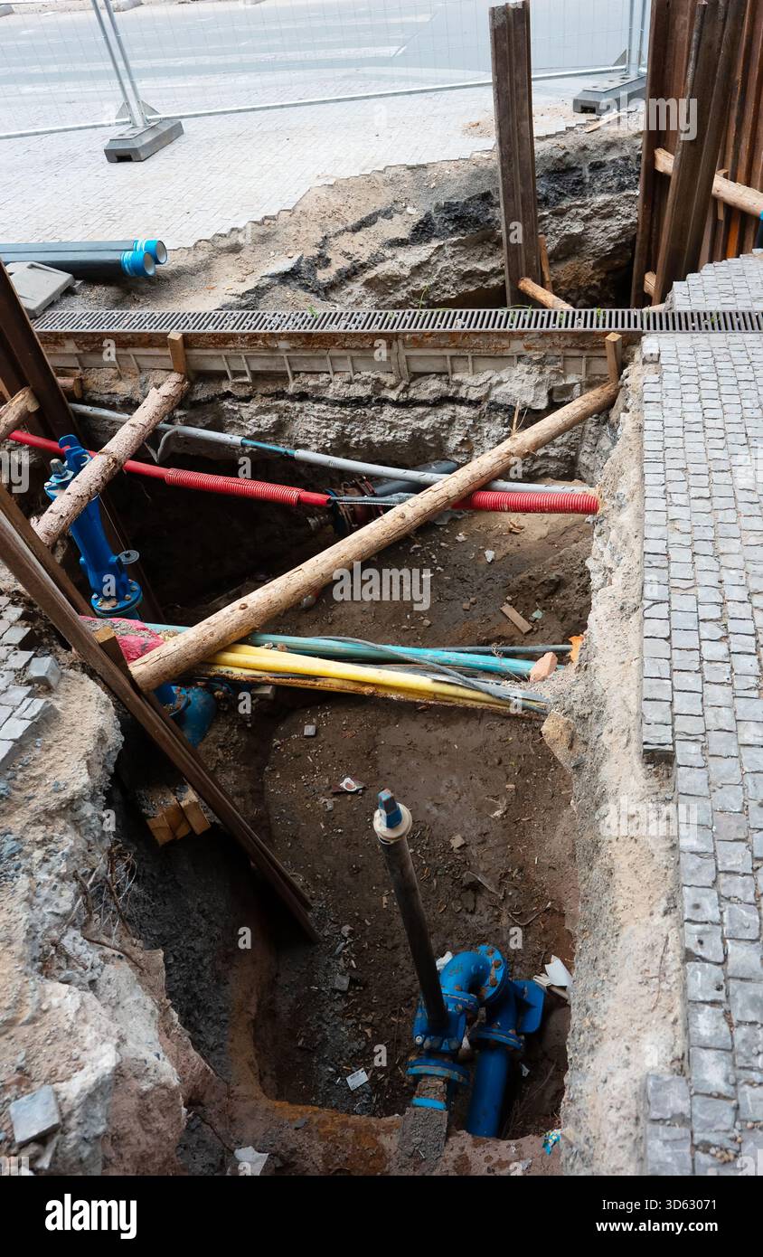 Trench excavated for urban utility pipe repair Stock Photo - Alamy