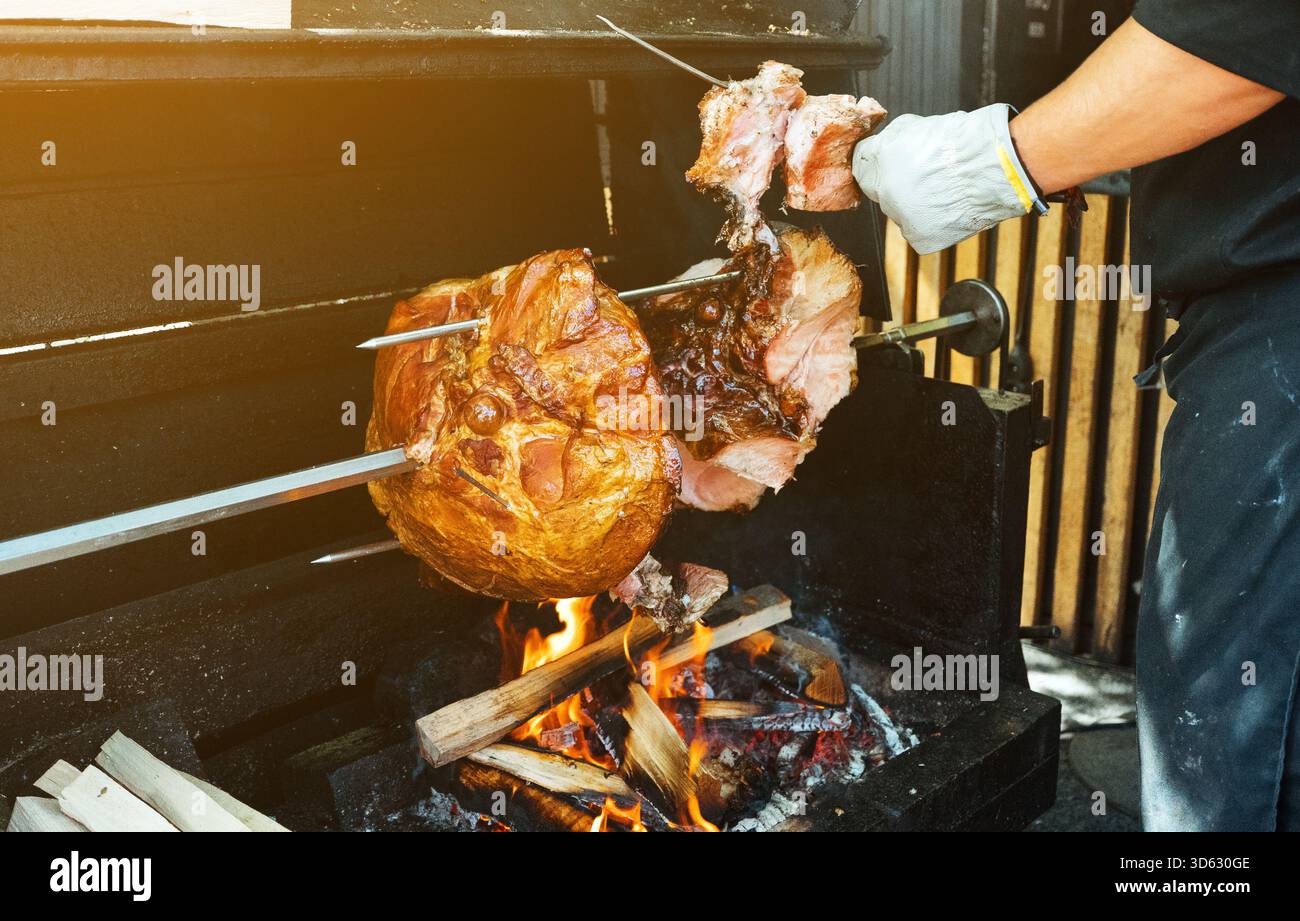 Traditional Prague pork street food roasting on spit Stock Photo - Alamy