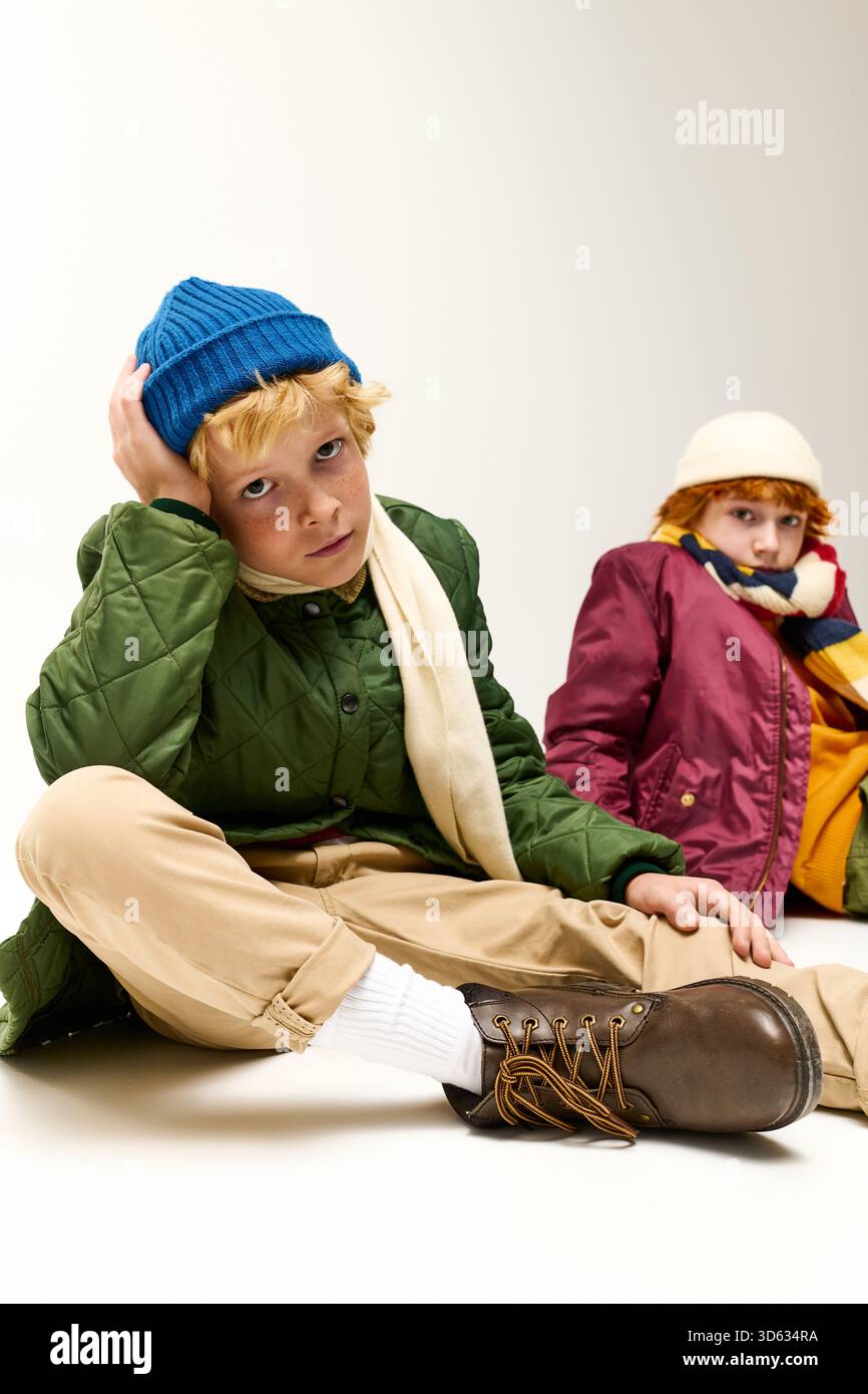 Two kids showcase their unique styles in cozy layers, blending playful ...