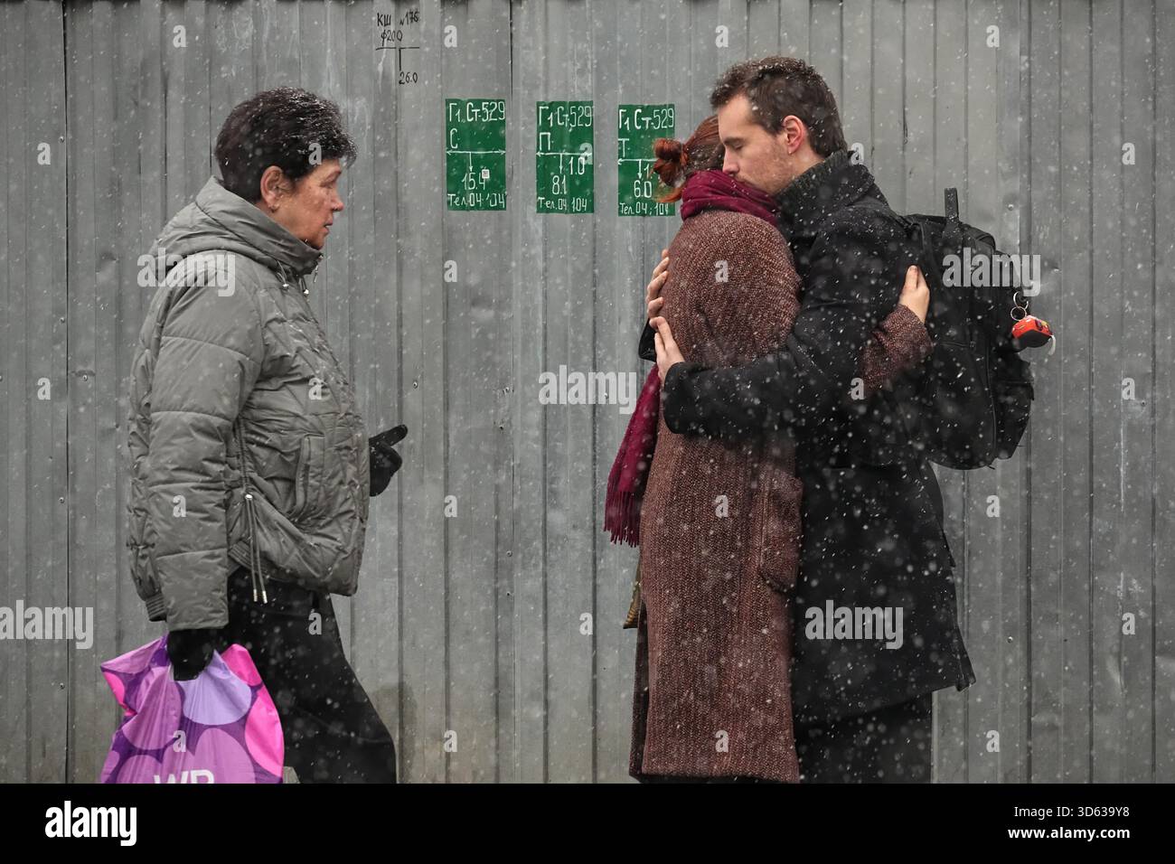 A couple hug during a snowfall in St. Petersburg, Russia, Tuesday, Nov ...