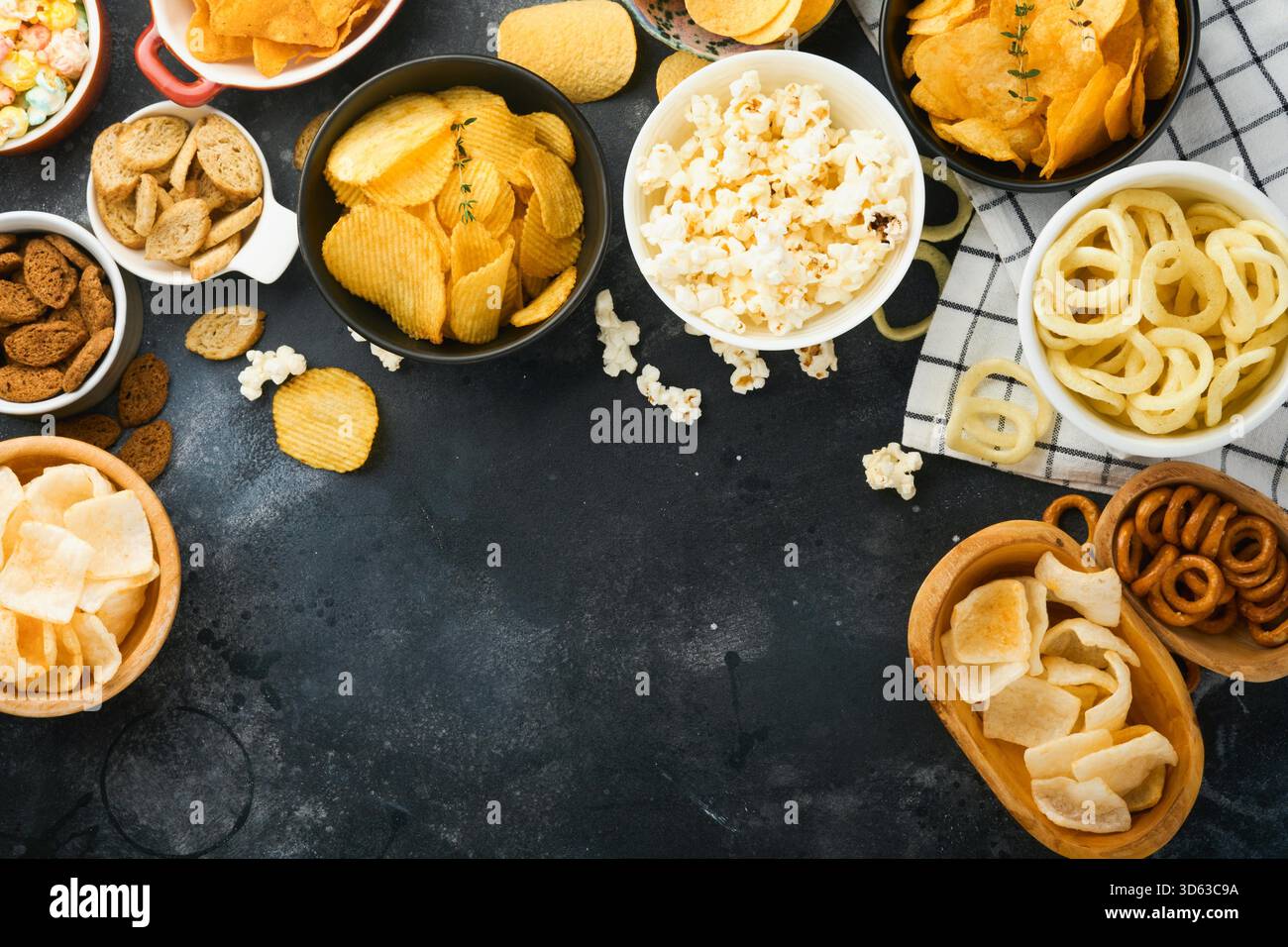 Unhealthy food. Snacks. All classic potato snacks with peanuts, popcorn ...