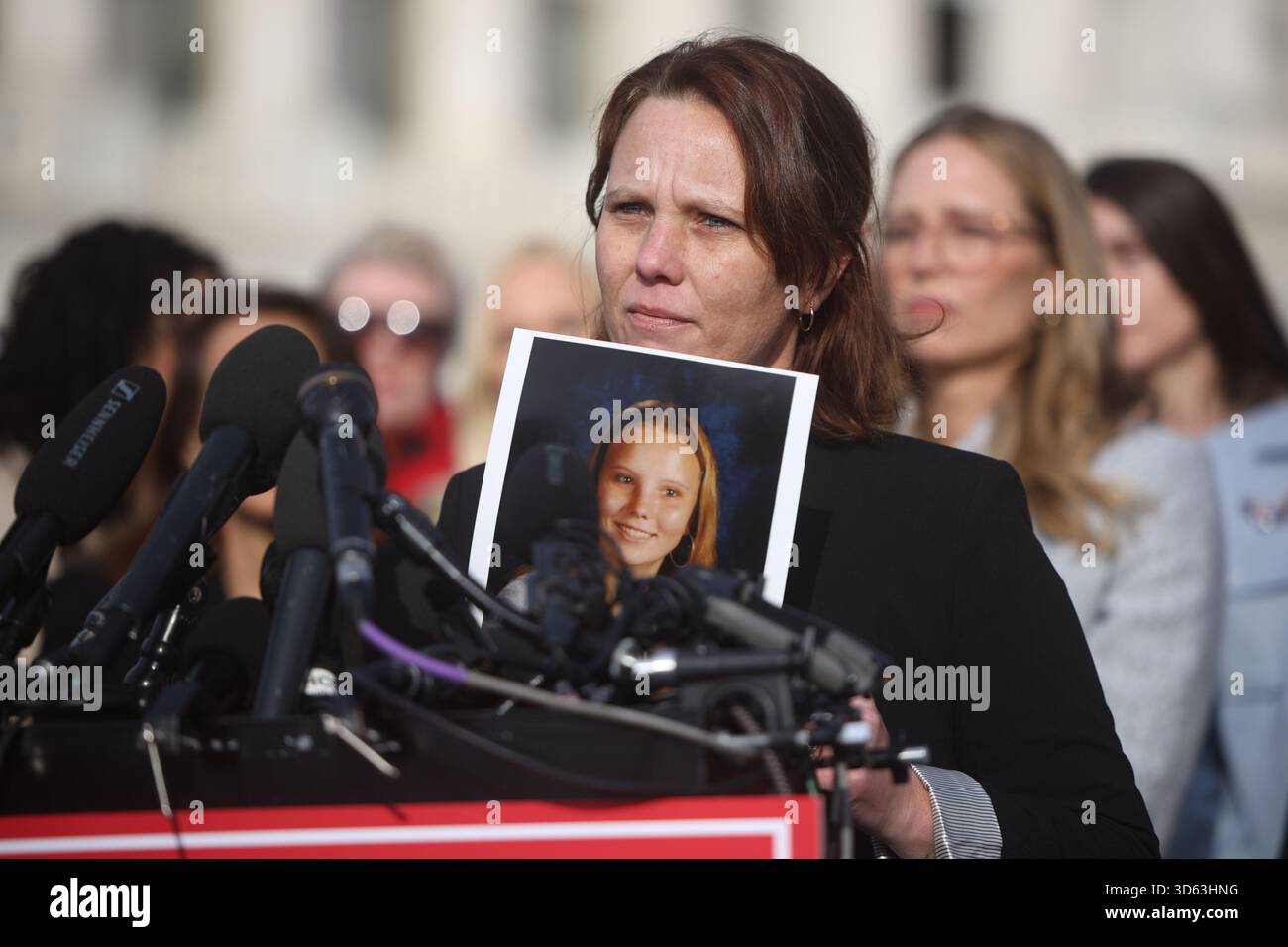 Jena-Lisa Jones, victim of Jeffrey Epstein, holds a photo of herself at ...
