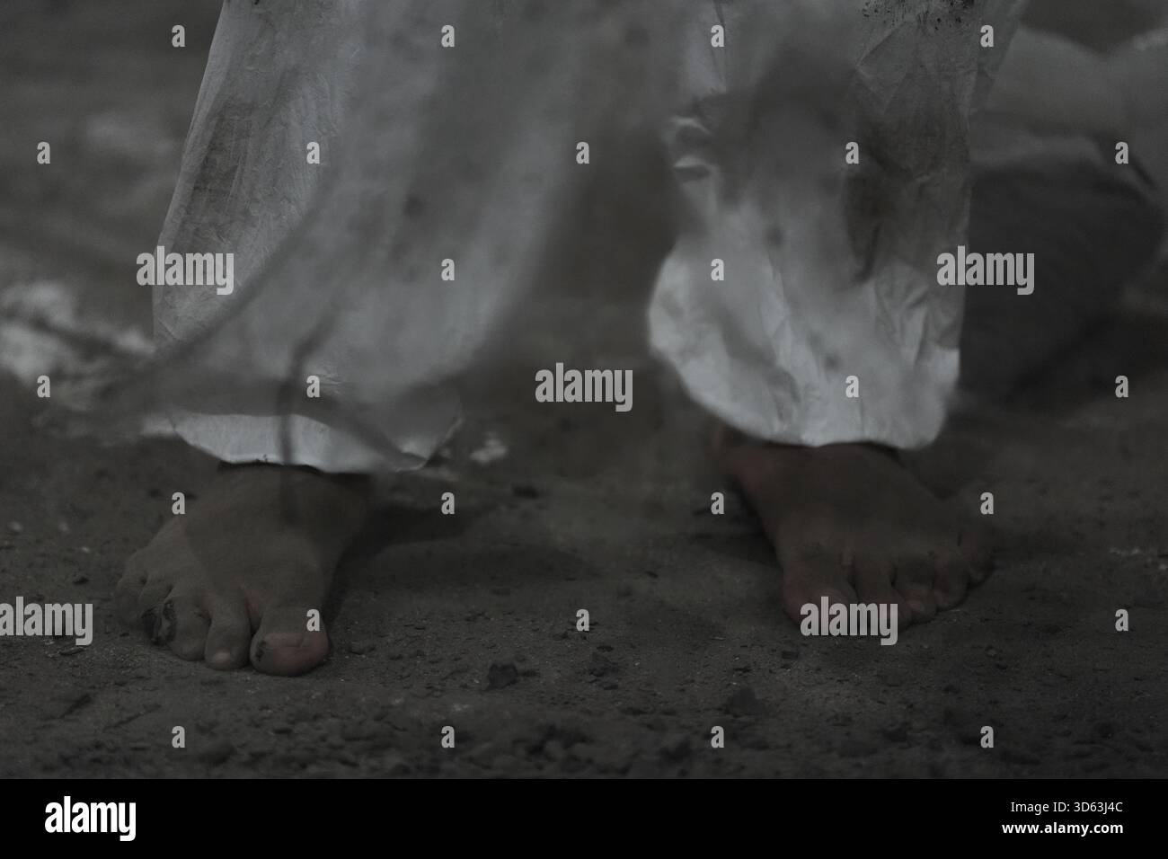 MUNDANO, a Brazilian artist, stands in ashes that he collected from ...