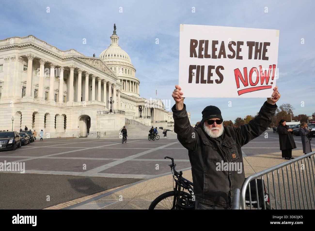 Lance Corey of New York holds a sign that says, "Release the files now ...