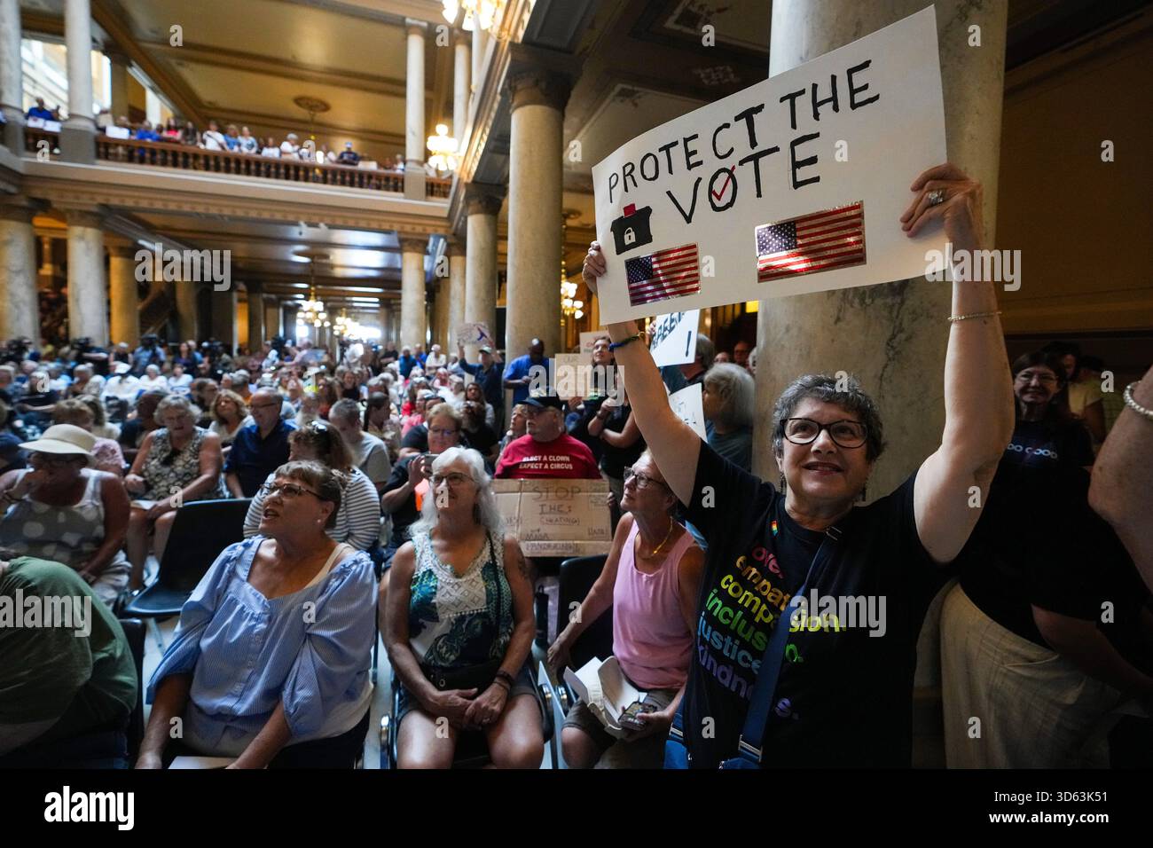 FILE - Annette Groos holds a sign before the start of a rally at the ...