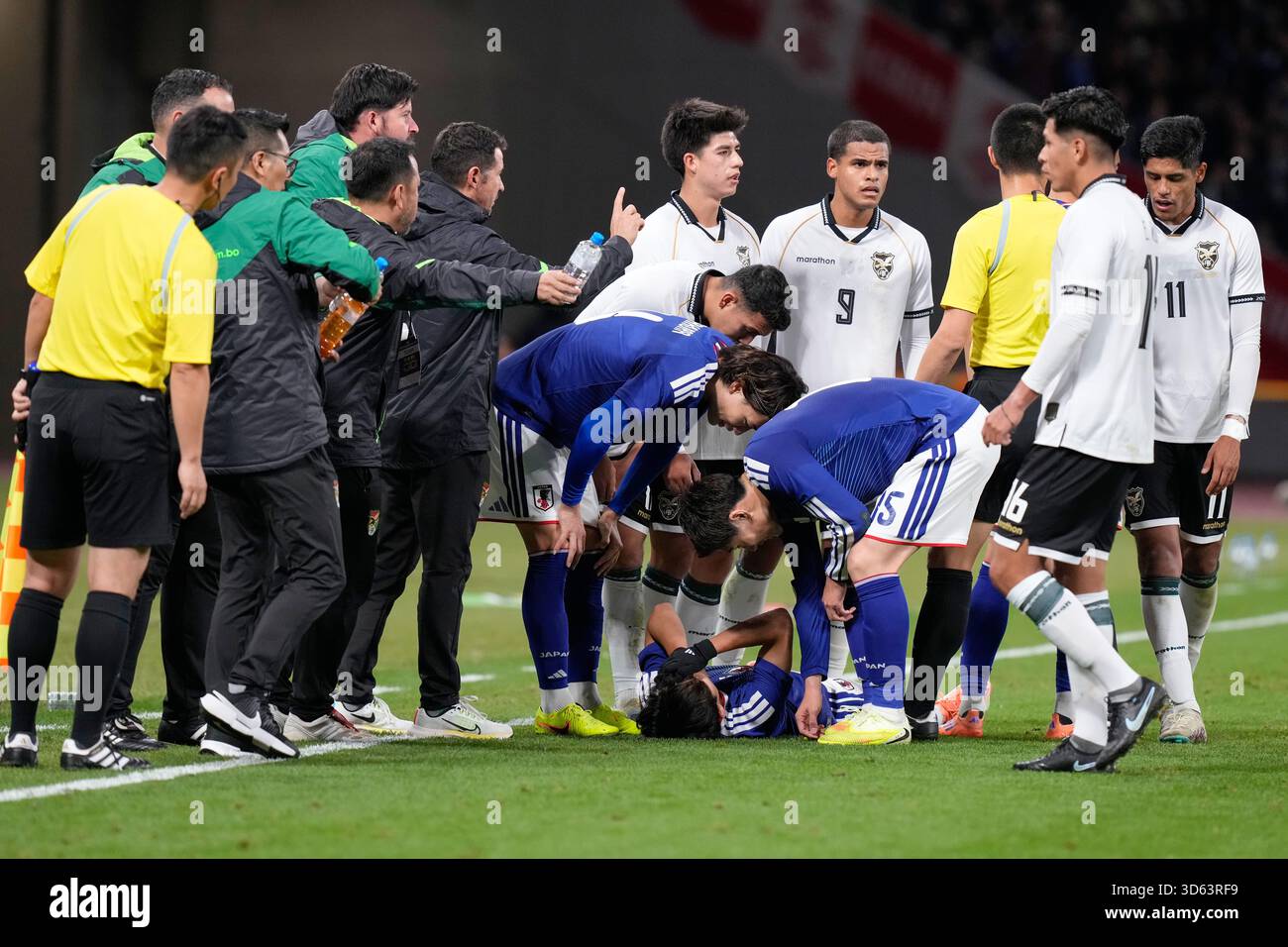 Japan's Takefusa Kubo, bottom, went down on the pitch as Japanese and ...