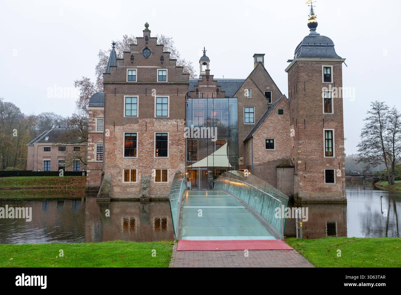 Brightly lit brick exterior facade of the Ruurlo castle with the glass ...