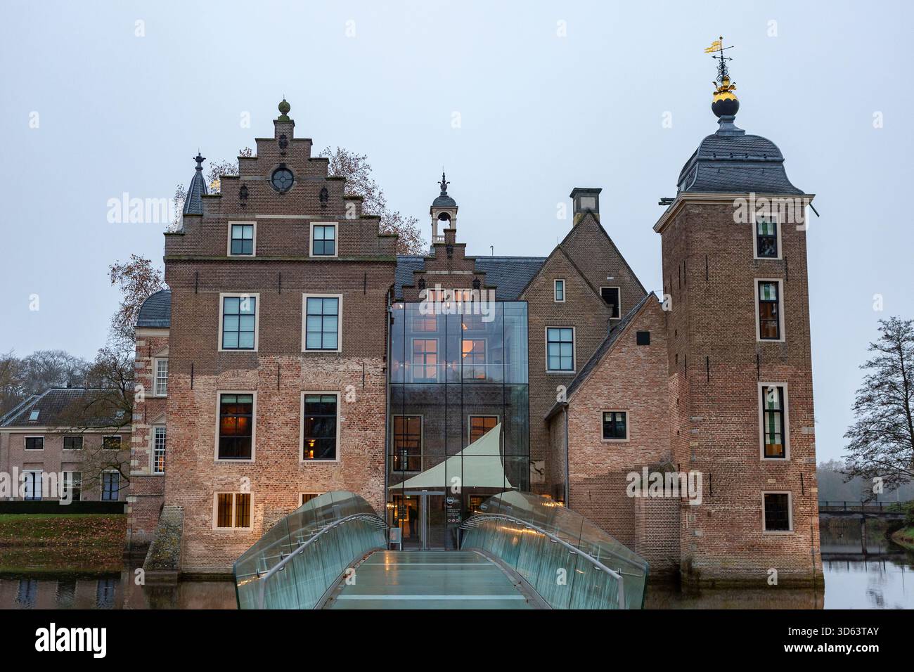 Brightly lit brick exterior facade of the Ruurlo castle with the glass ...