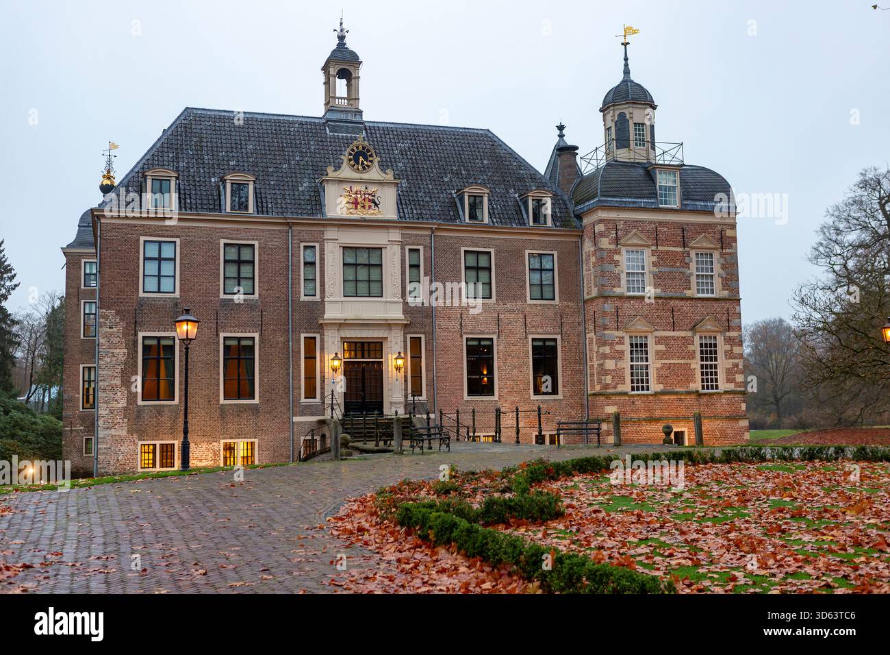 Brightly lit brick exterior facade of the Ruurlo castle with the glass ...