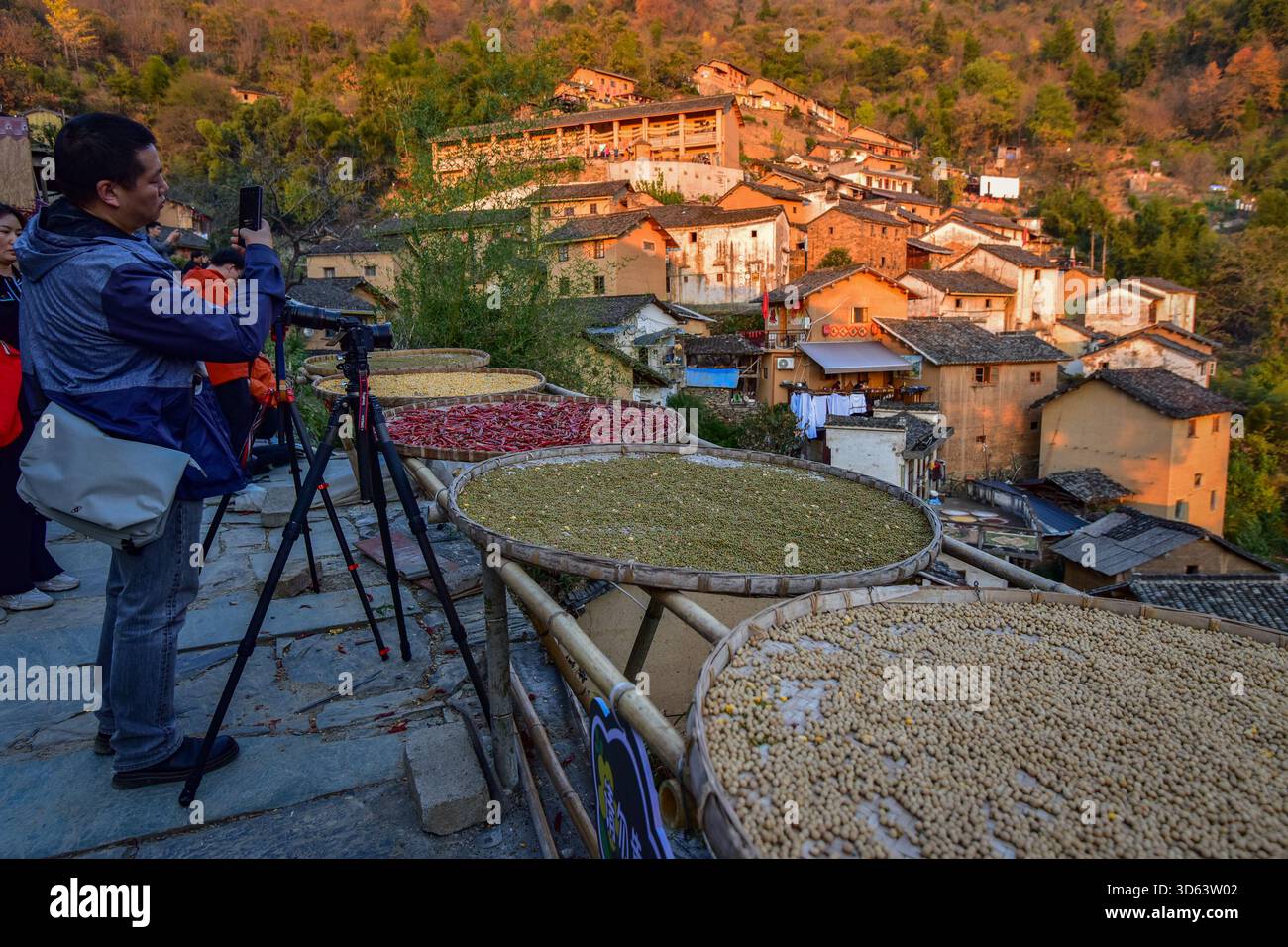 A photographer captures the picturesque scene of Yangchan Tulou with ...