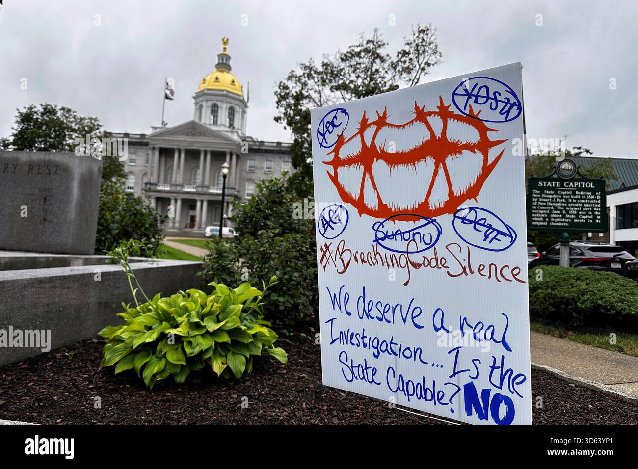 FILE - A sign calling for a federal investigation into New Hampshire's ...