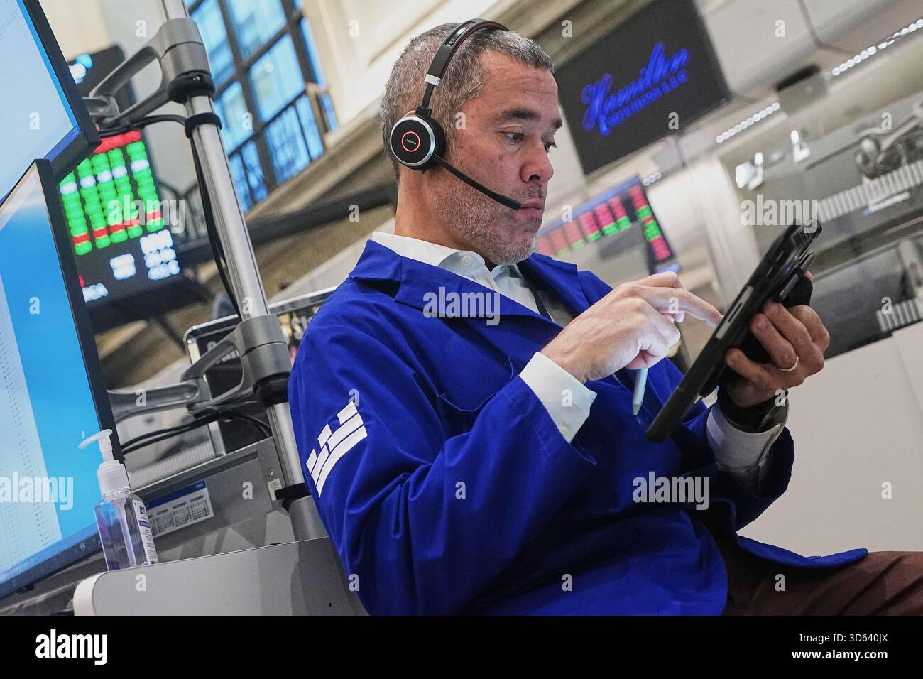 Options trader Justin Kanda works on the floor of the New York Stock ...