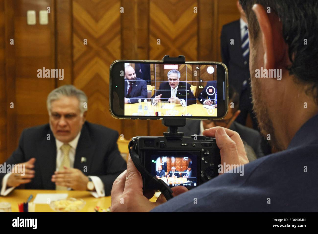 A journalist films as Pakistani Deputy Prime Minister and Foreign ...