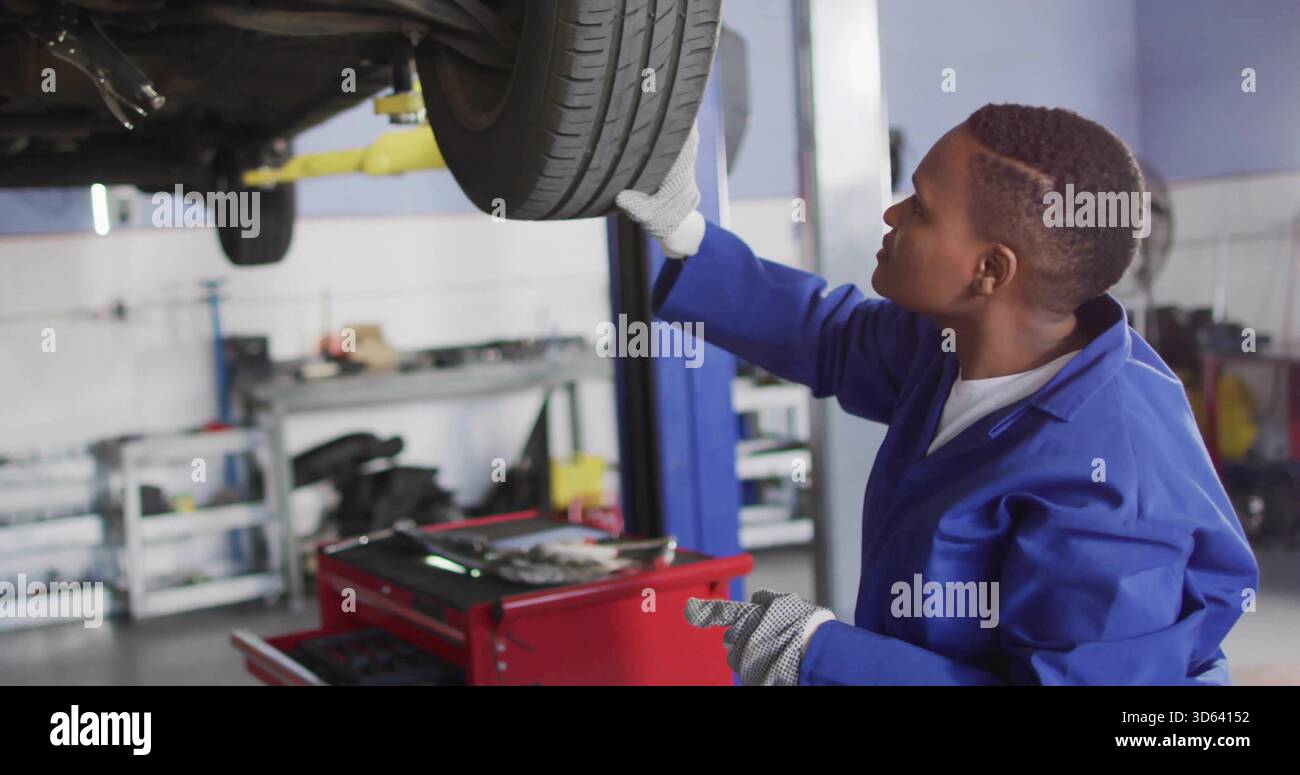 Inspecting tire on vehicle lift hi-res stock photography and images - Alamy