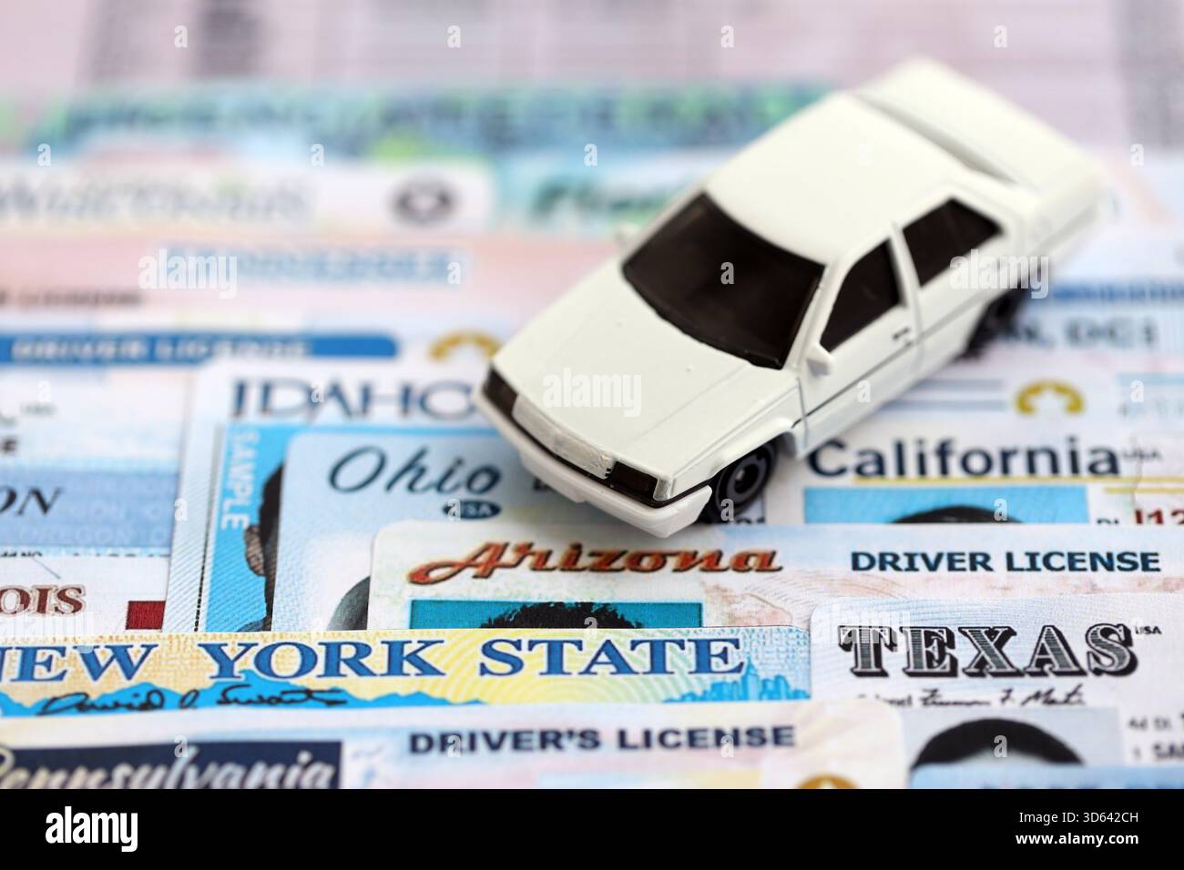 Toy car on big amount of driving licenses from different USA states ...