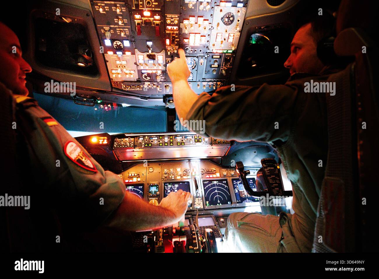18 November 2025, Berlin: Two pilots sit in the cockpit of the ...