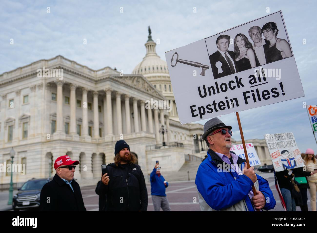 Protesters hold signs during a news conference on the Epstein Files ...