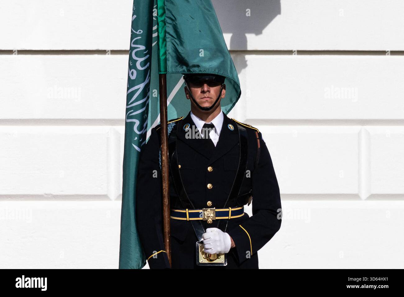 An army soldier holds a Saudi Arabian flag ahead of a welcome ceremony ...