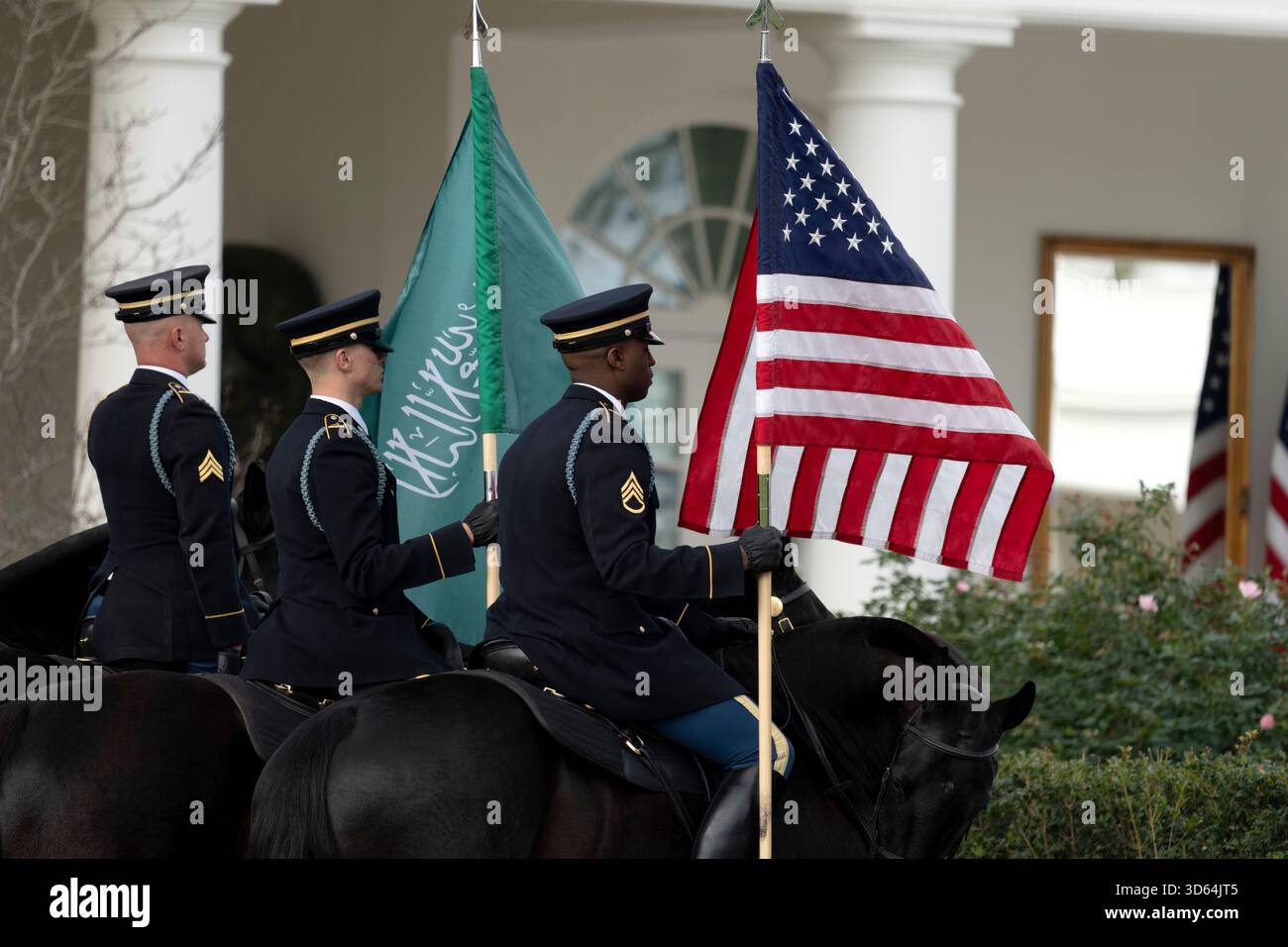 Members of a mounted honor guard hold Saudi Arabian and American flags ...