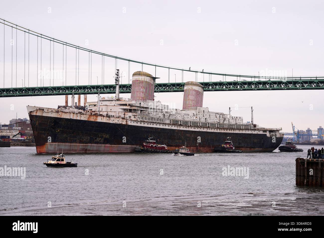 FILE - The SS United States is towed down the Delaware River between ...