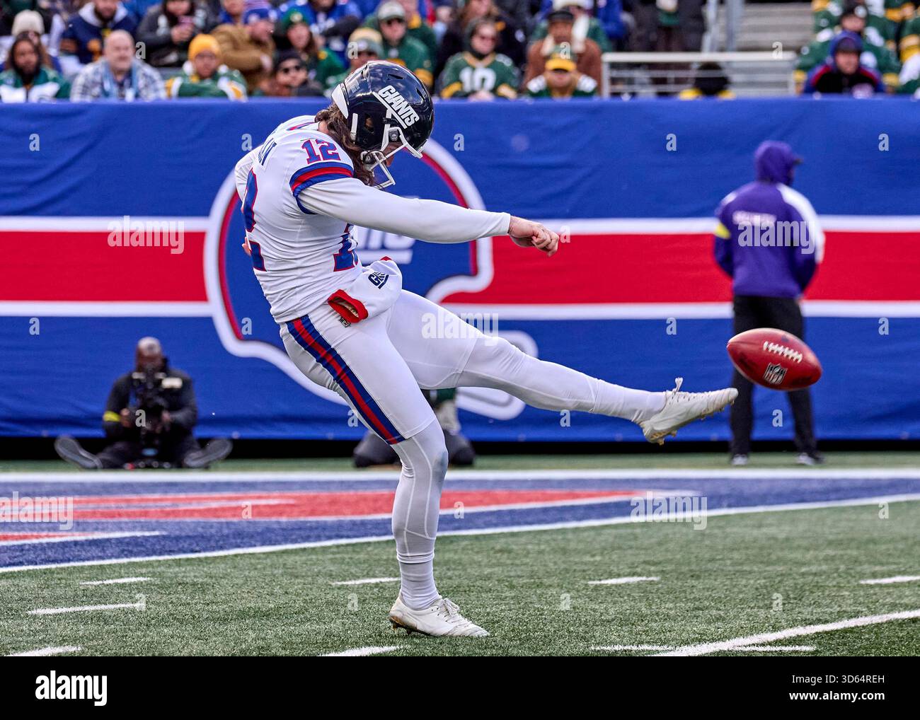 New York Giants punter Jamie Gillan (12) punters against the Green Bay ...