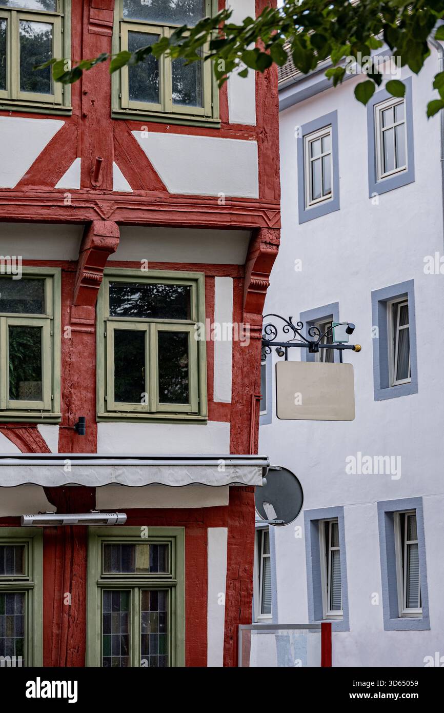 Close-up of a traditional half-timbered house with red wooden beams and ...