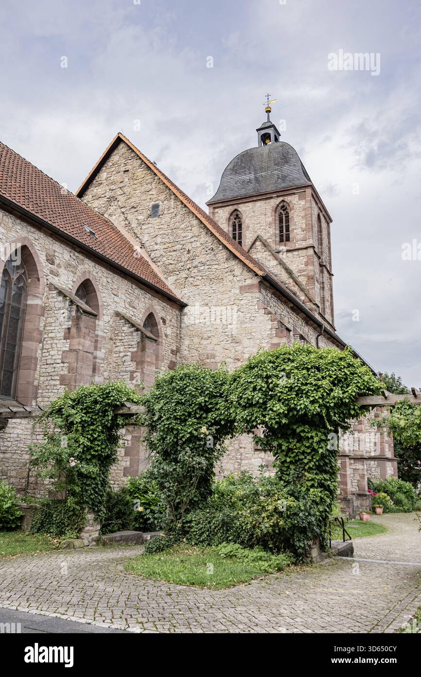Historic stone church with arched windows and a tower surrounded by ...