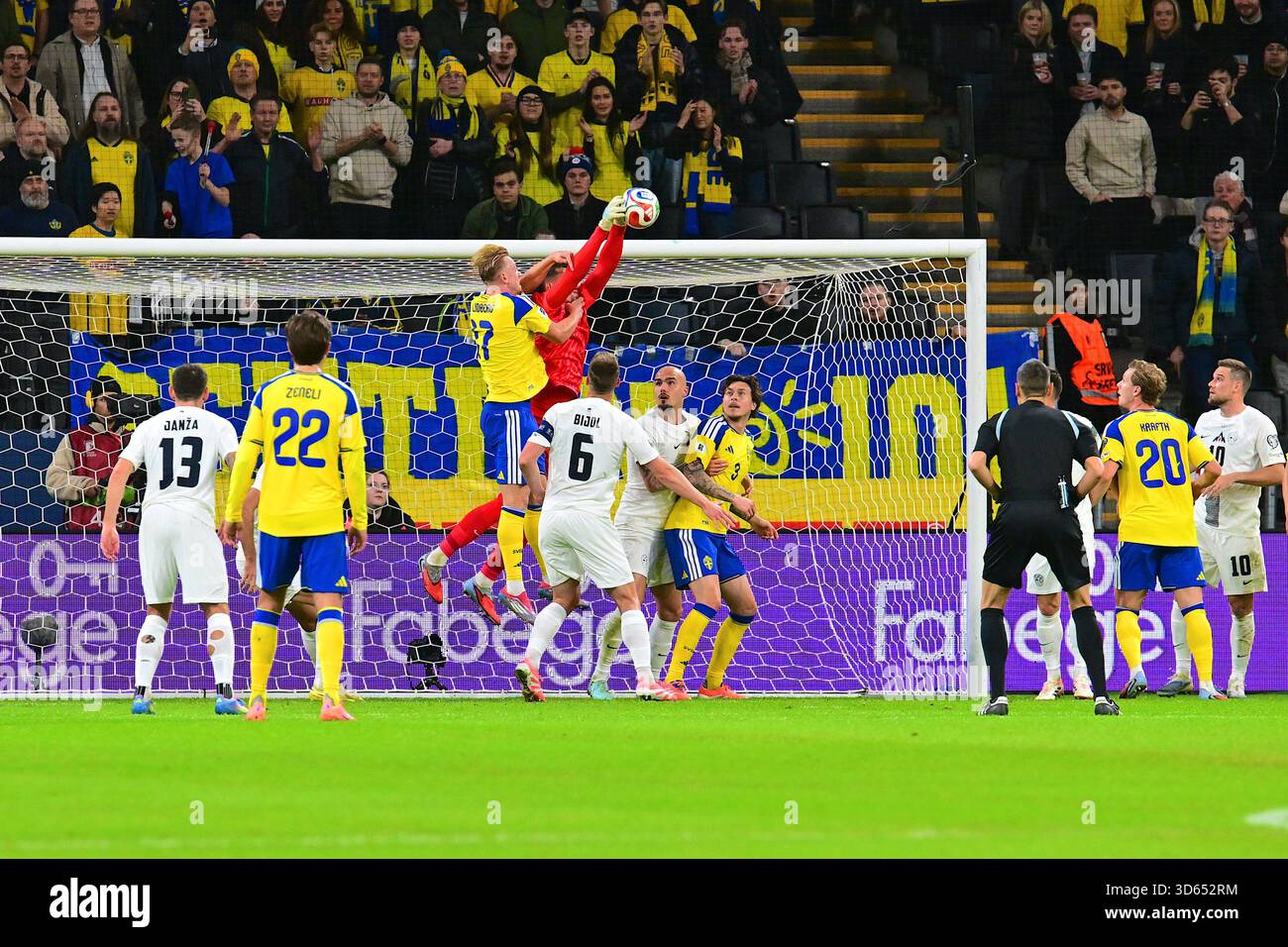 Isac Lidberg (17 Sweden) and goalkeeper Igor Vekic (1 Slovenia) in a ...