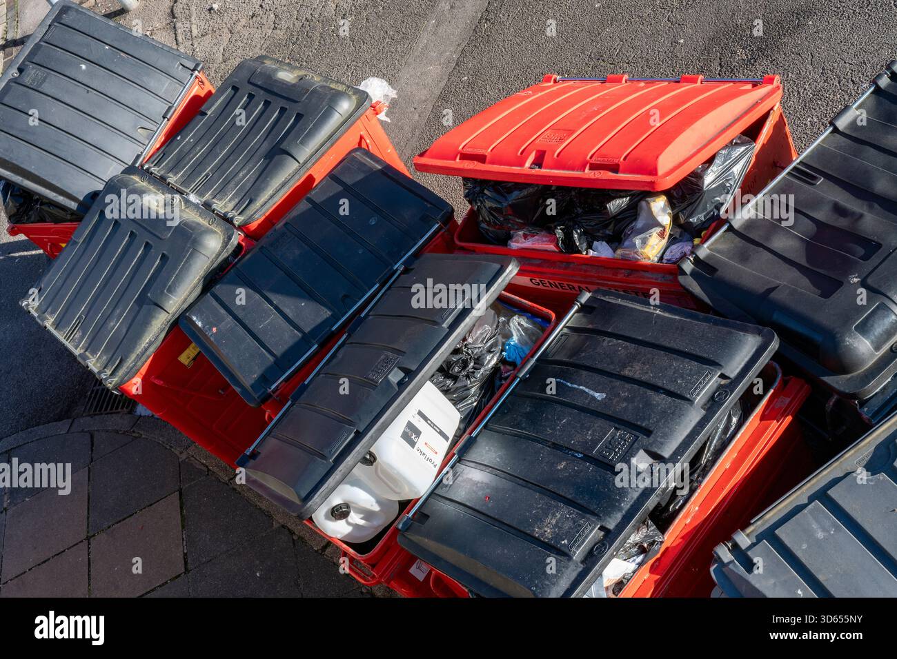 collection of large plastic lidded wheelie bins full to capacity ready ...