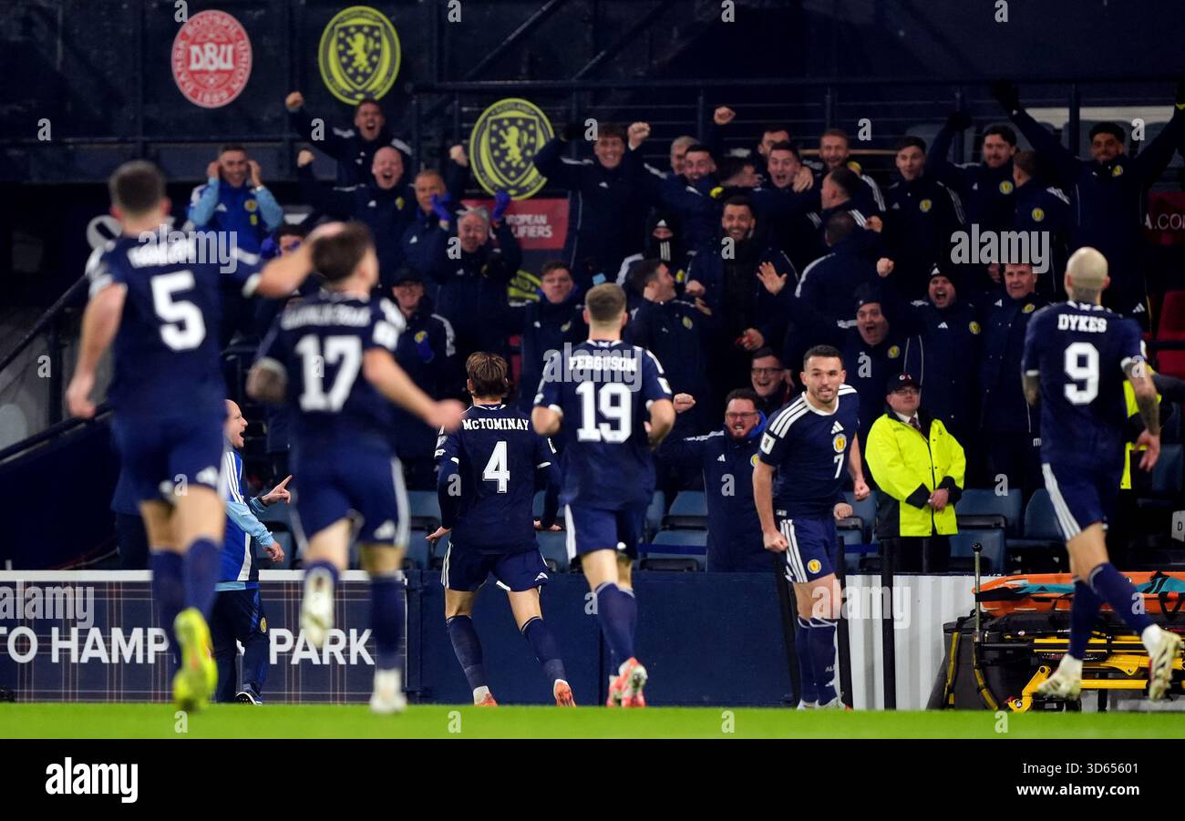 Scotland's Scott McTominay runs to the team bench after scoring the opening goal during the FIFA ...