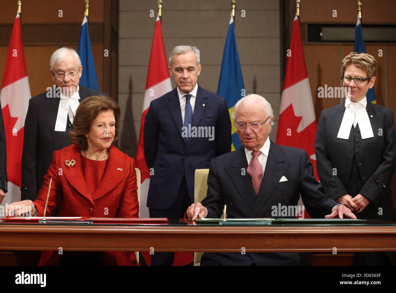 Sweden's King Carl Gustaf and Queen Silvia sign a guest book as Prime ...