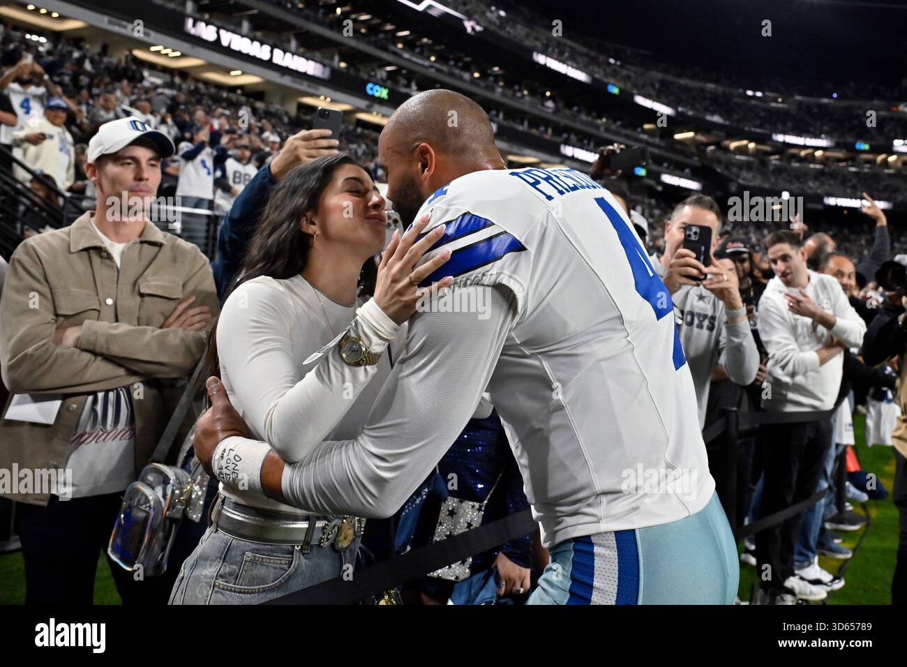 Dallas Cowboys quarterback Dak Prescott, right, greets his fiancée ...