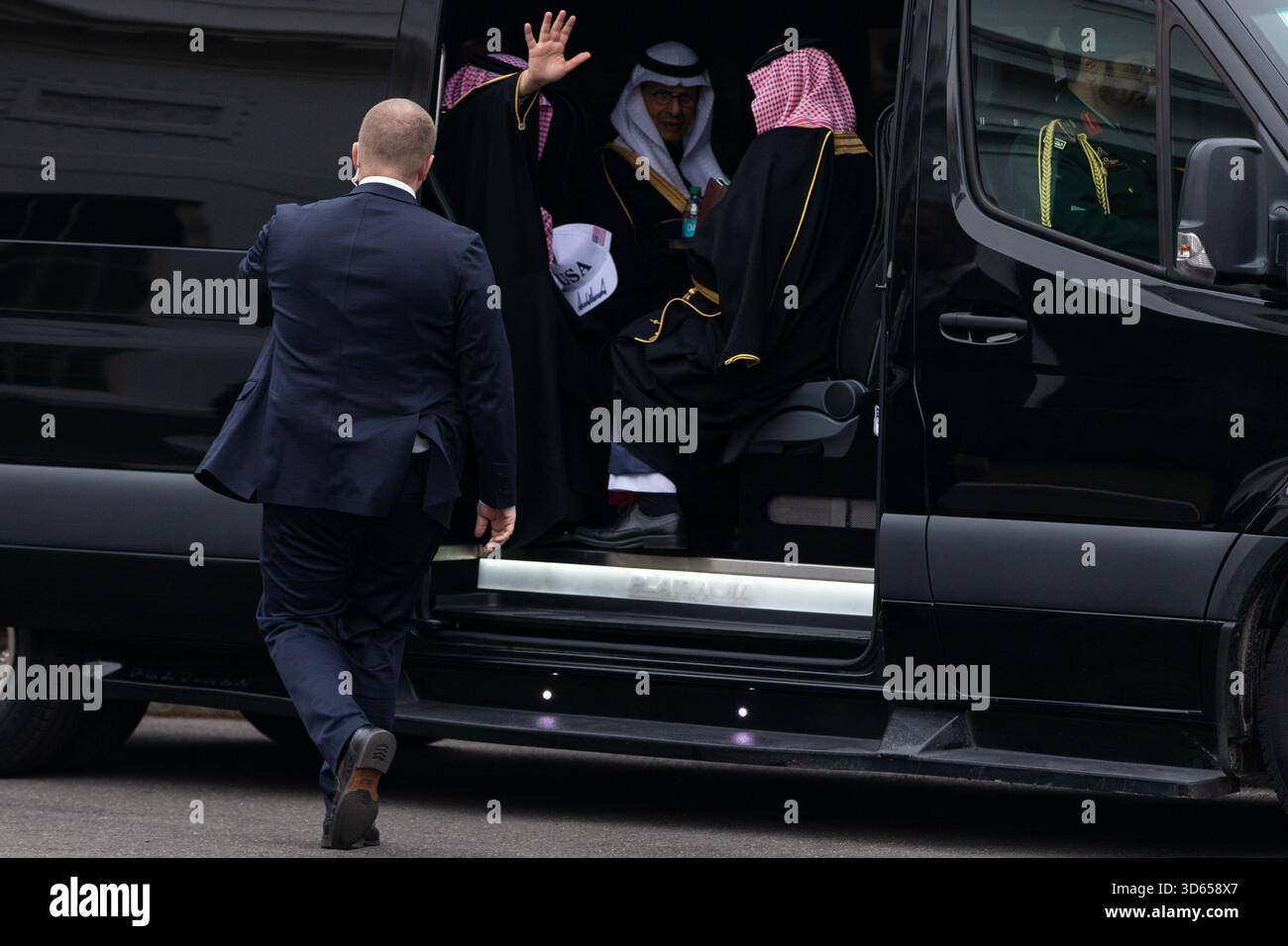 Members of the Saudi Arabian delegation load into a van to depart the ...
