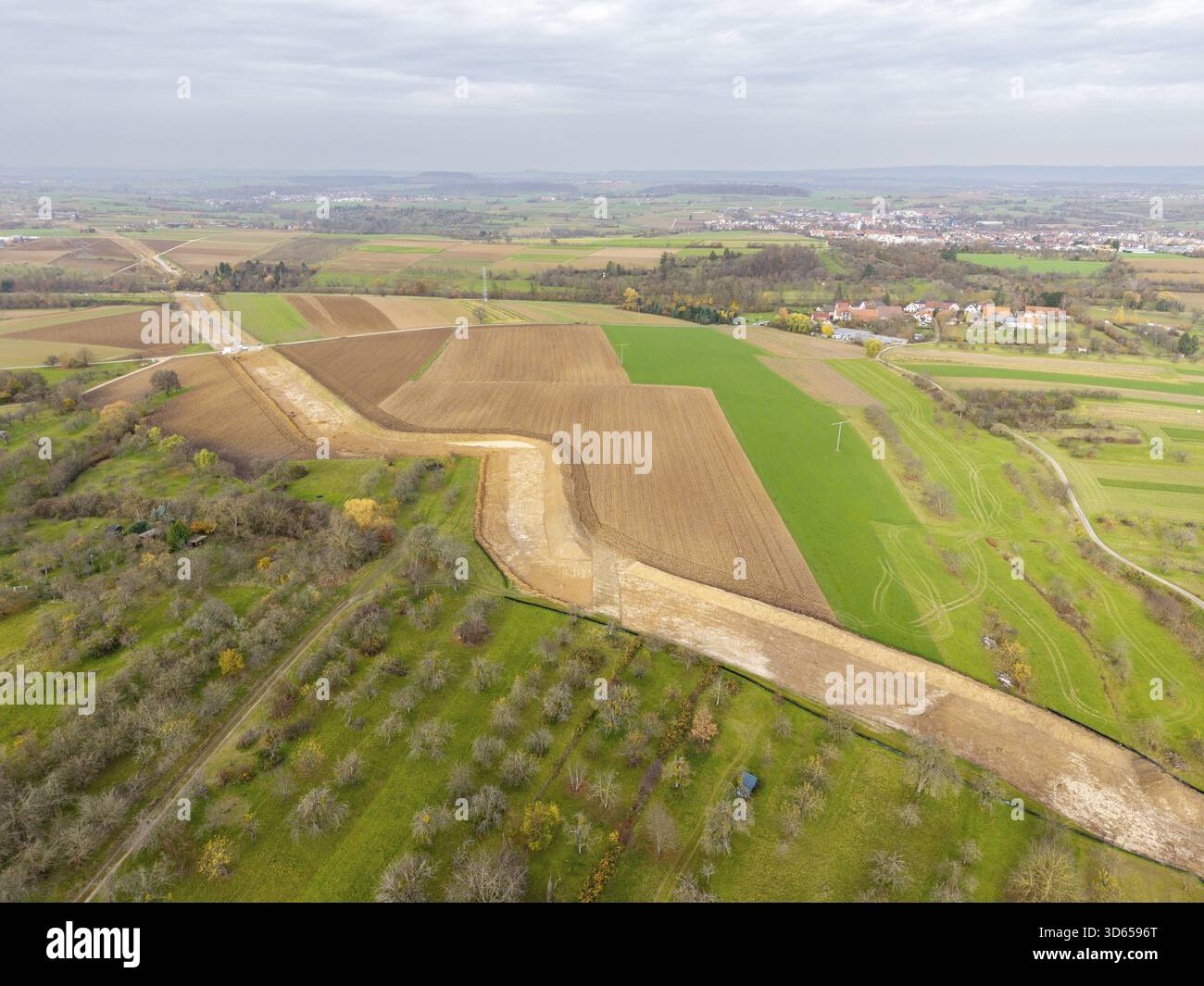Aerial view of a rural region with fields and a faraway town ...