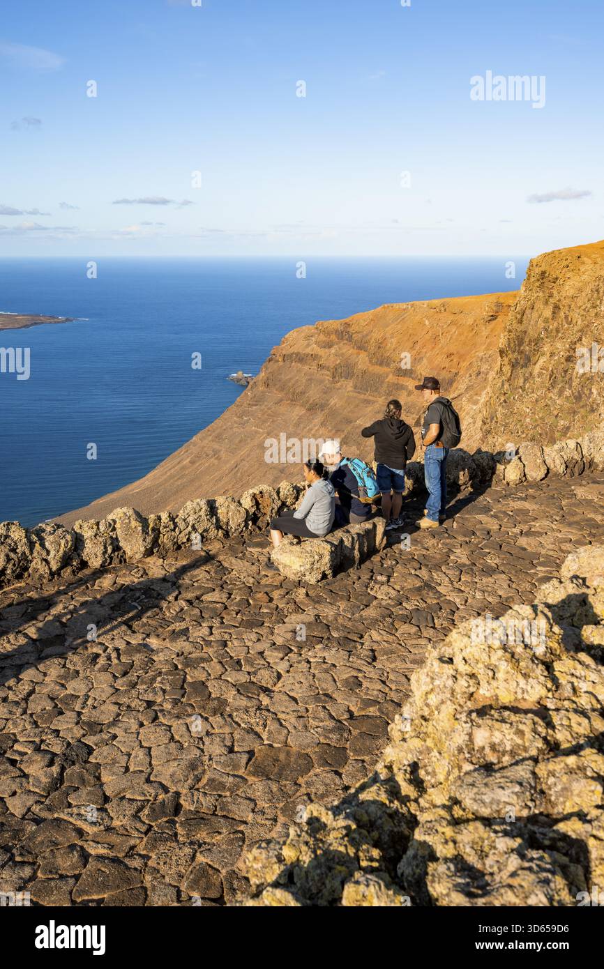 Tourists sitting on a bench on the observation deck at the Mirador del ...