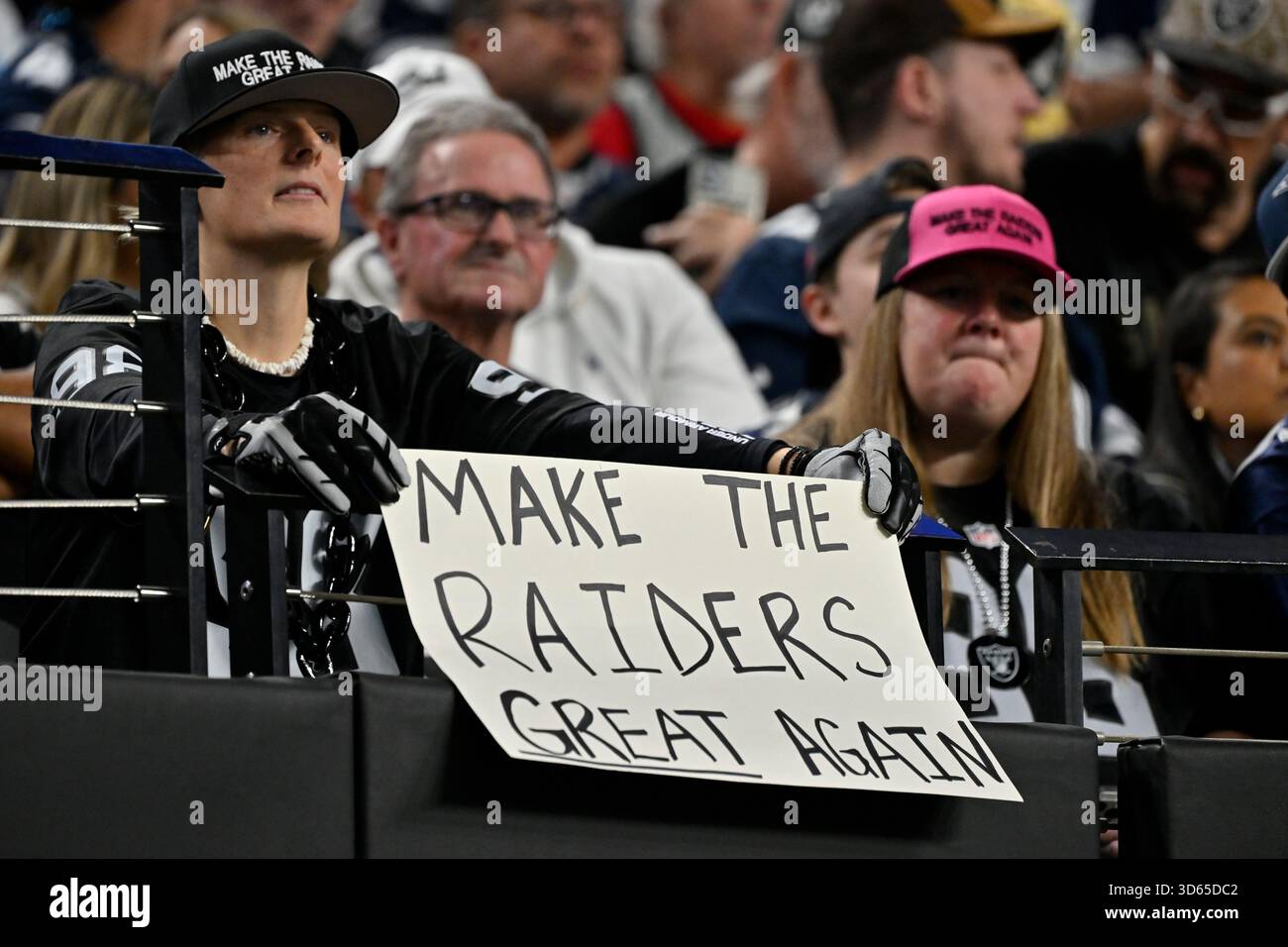 A Las Vegas Raiders fan displays a "Make the Raiders Great Again" sign ...