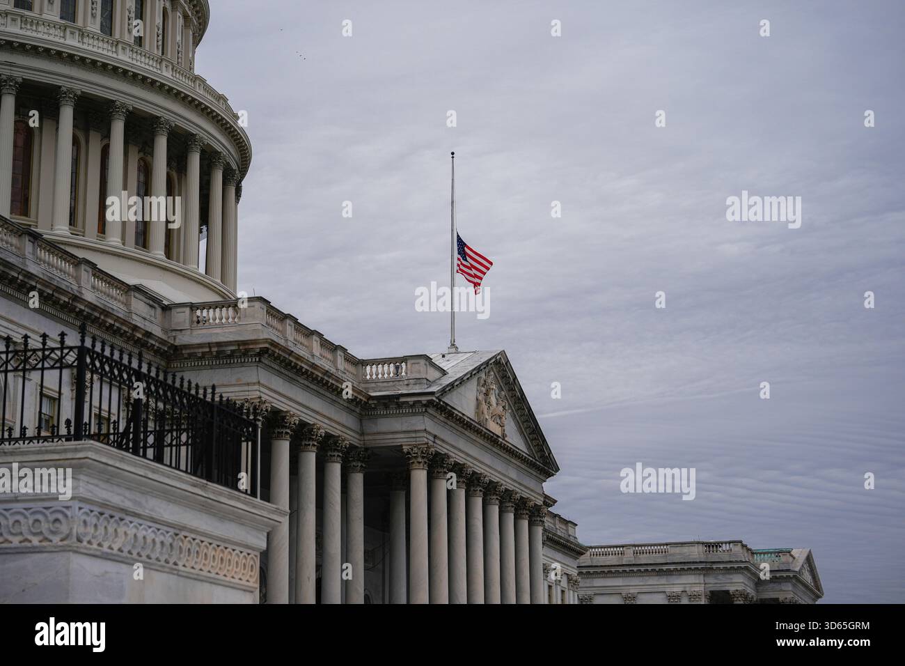 The American flag flies half-staff outside the U.S. Capitol, Tuesday ...