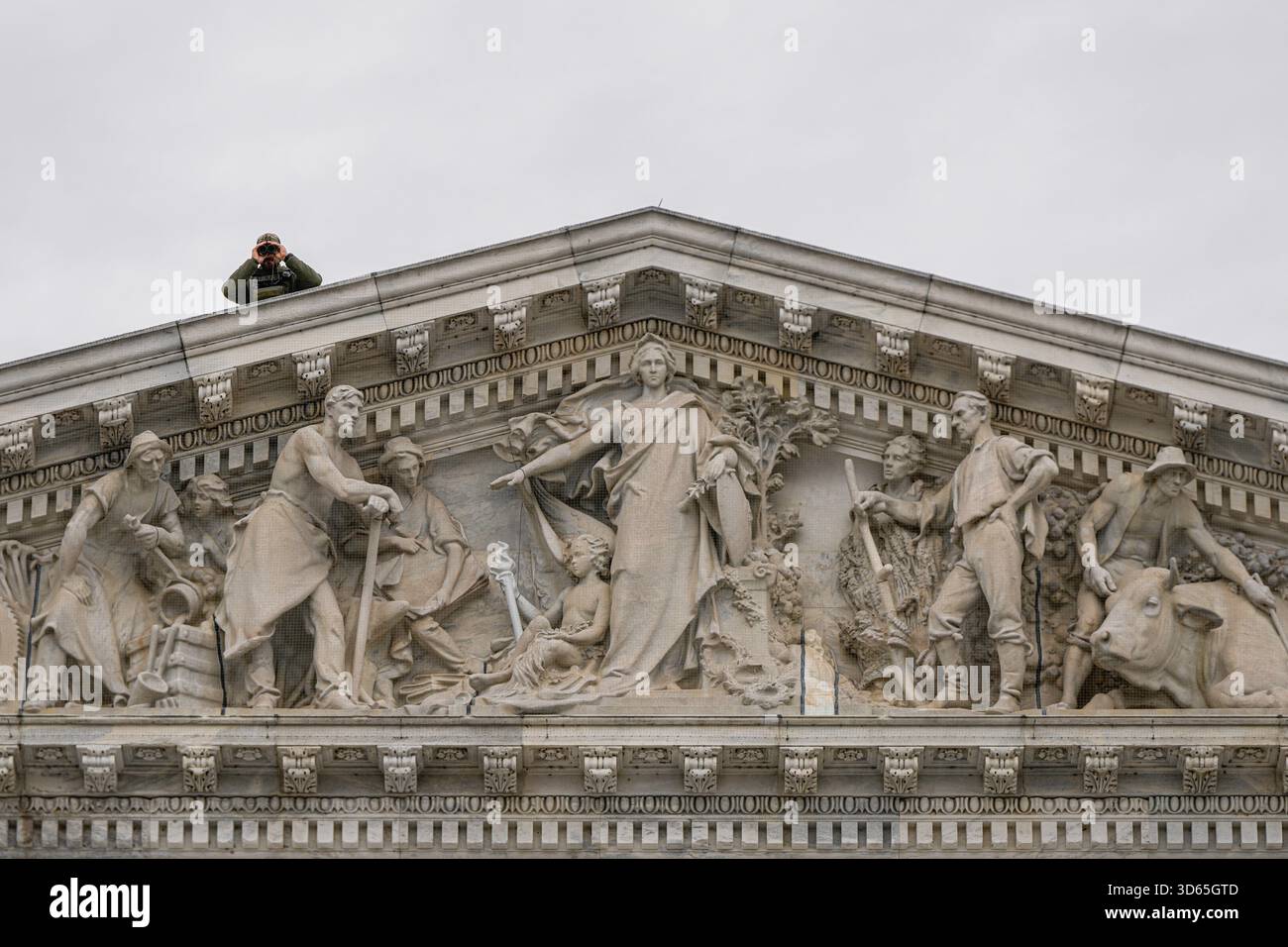 A sniper watches from the roof of the U.S. Capitol during a House vote ...