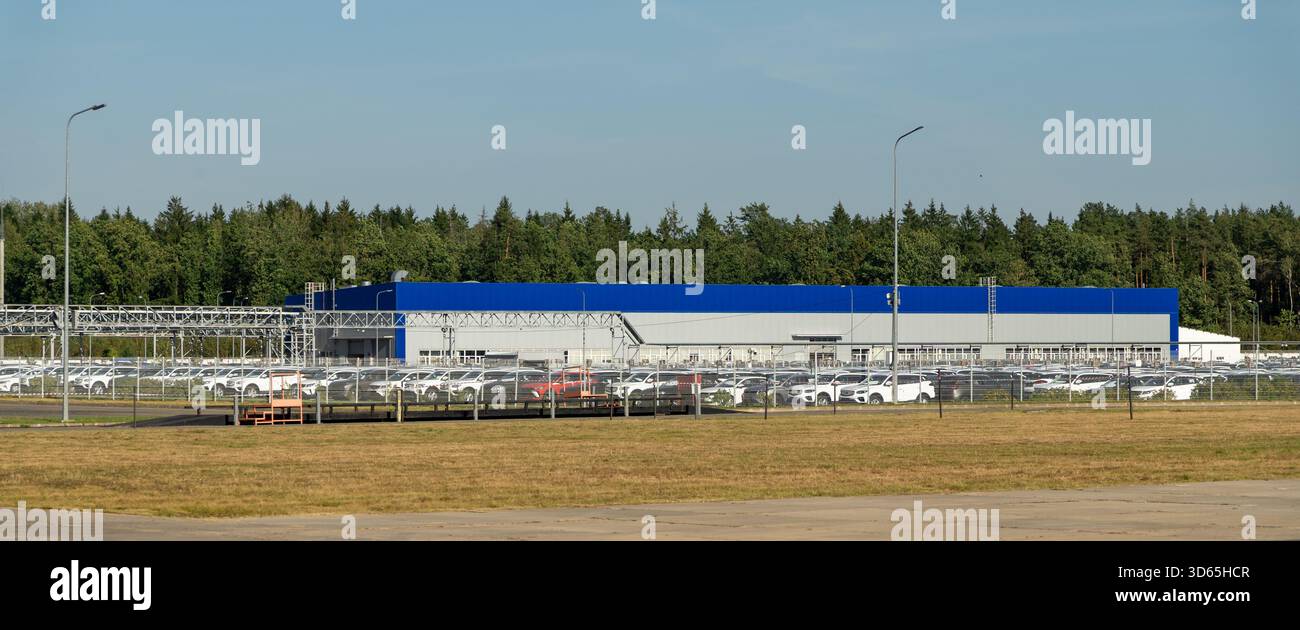 Aerial view of a vast parking lot filled with newly manufactured cars ...