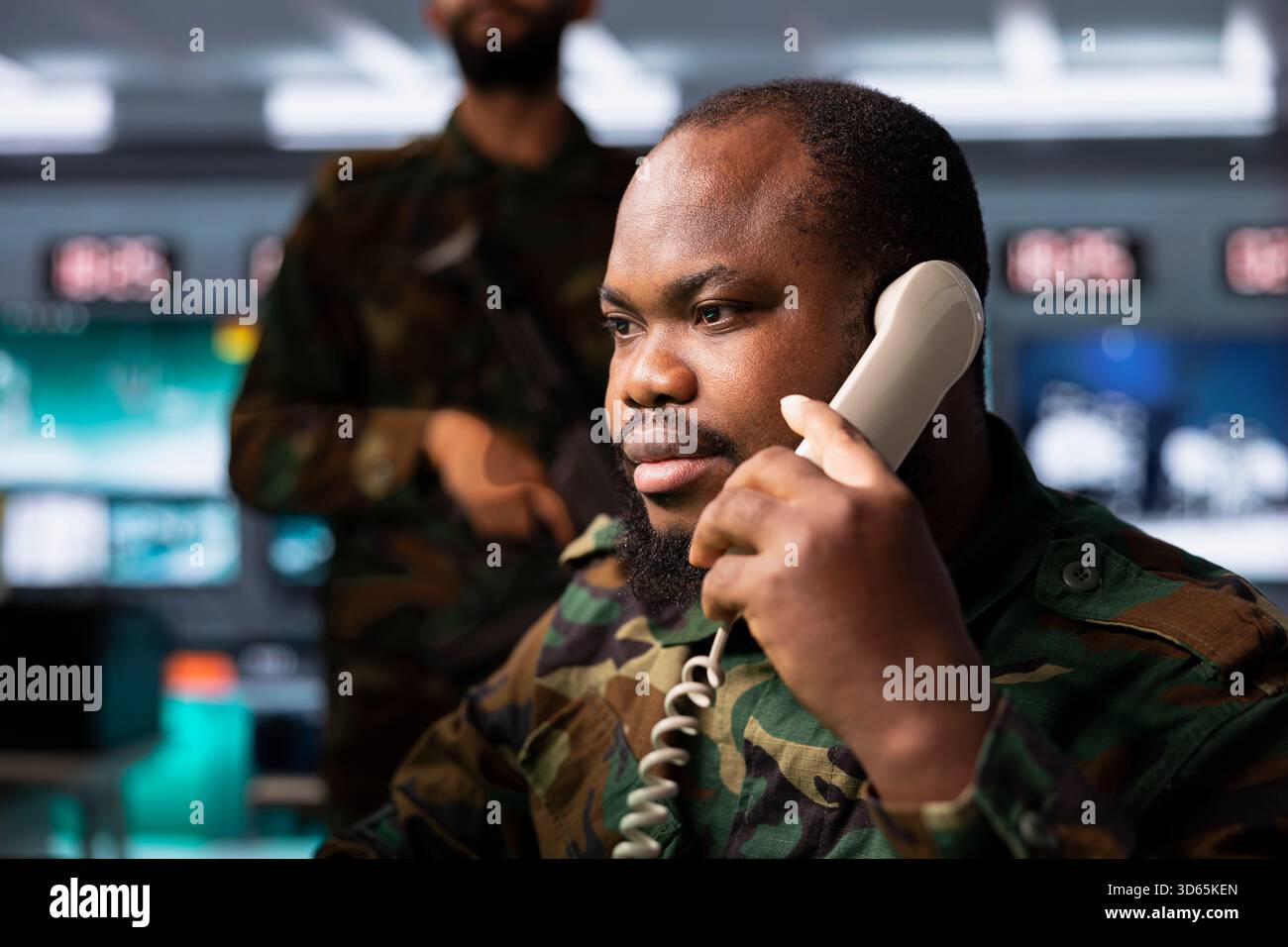 Army dispatcher looking at radar surveillance transmission on screens ...