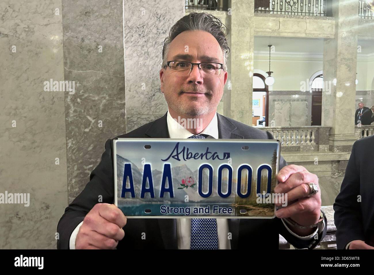 Service Alberta Minister Dale Nally holds an example of the winning ...