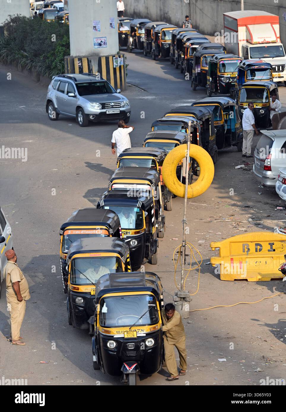 MUMBAI, INDIA - NOVEMBER 18: Long line of autorickshaws wait outside ...