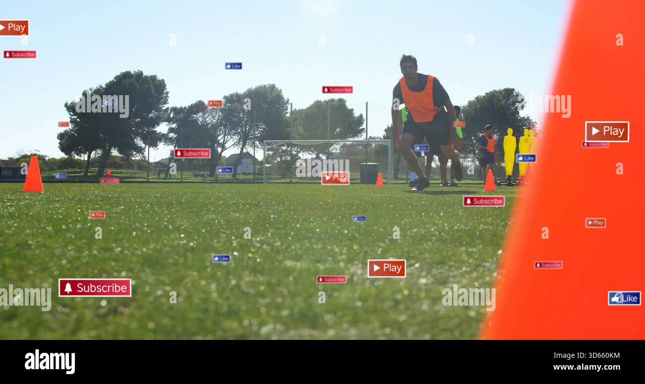 Preparing male athlete orange bib launching sprint on grass pitch with ...
