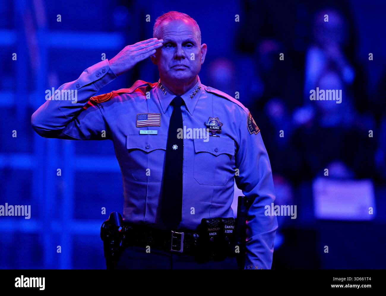 San Bernardino County Sheriff Shannon Dicus salutes during funeral ...